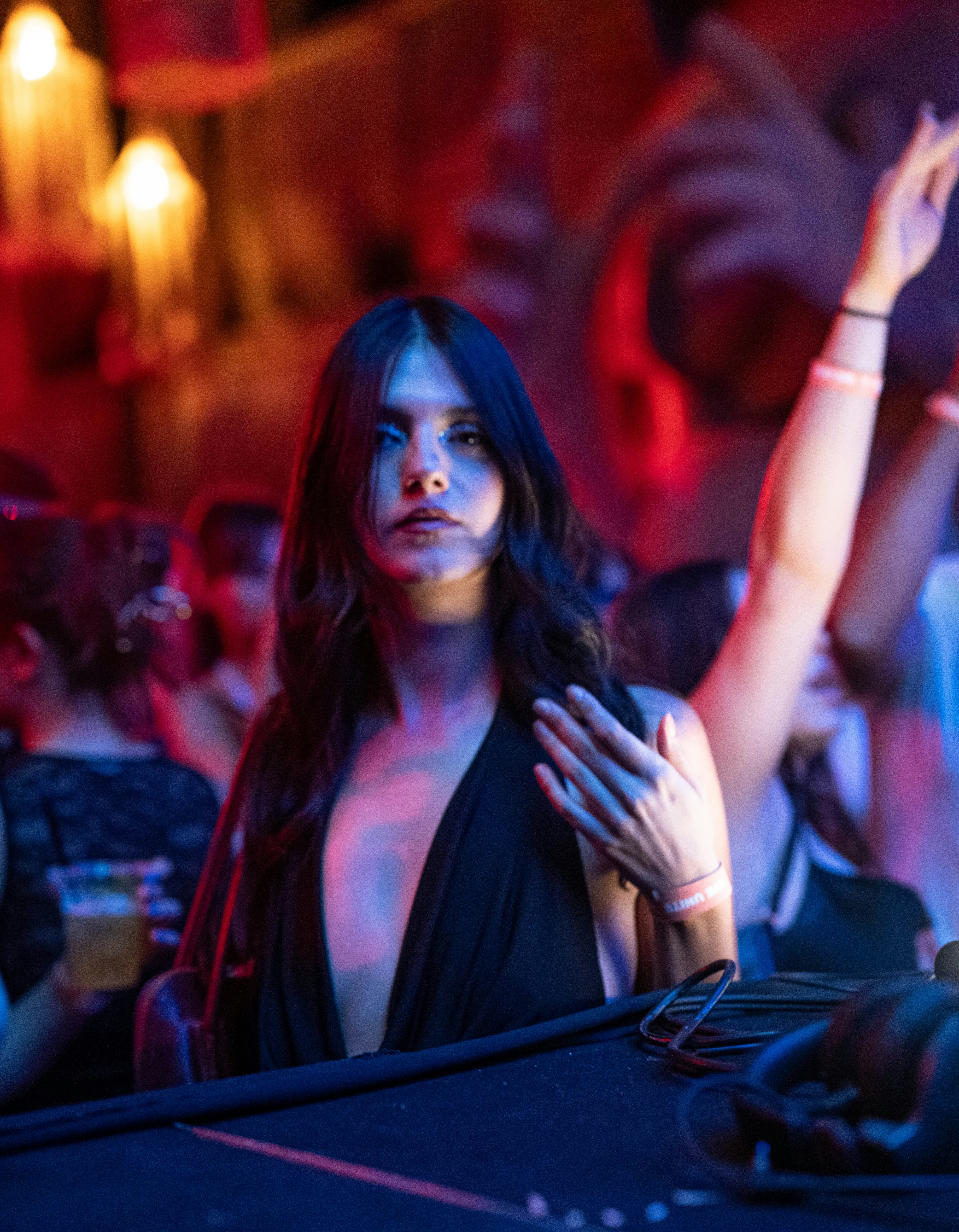 Neon Gaze in the Crowd: A Quiet Club Portrait