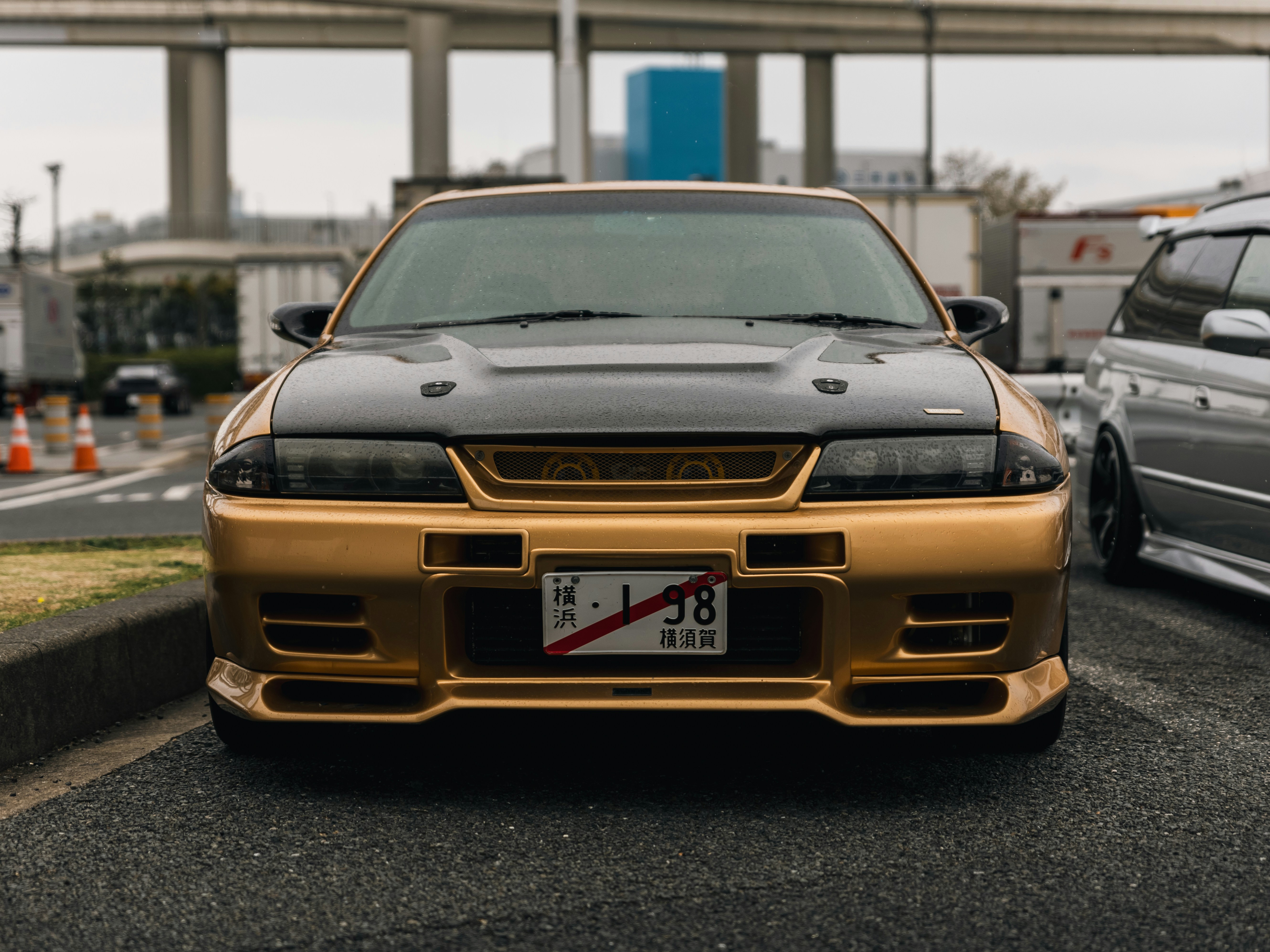 Gold-Fronted Japanese Sport Coupe Anchors a Quiet Parking Lot