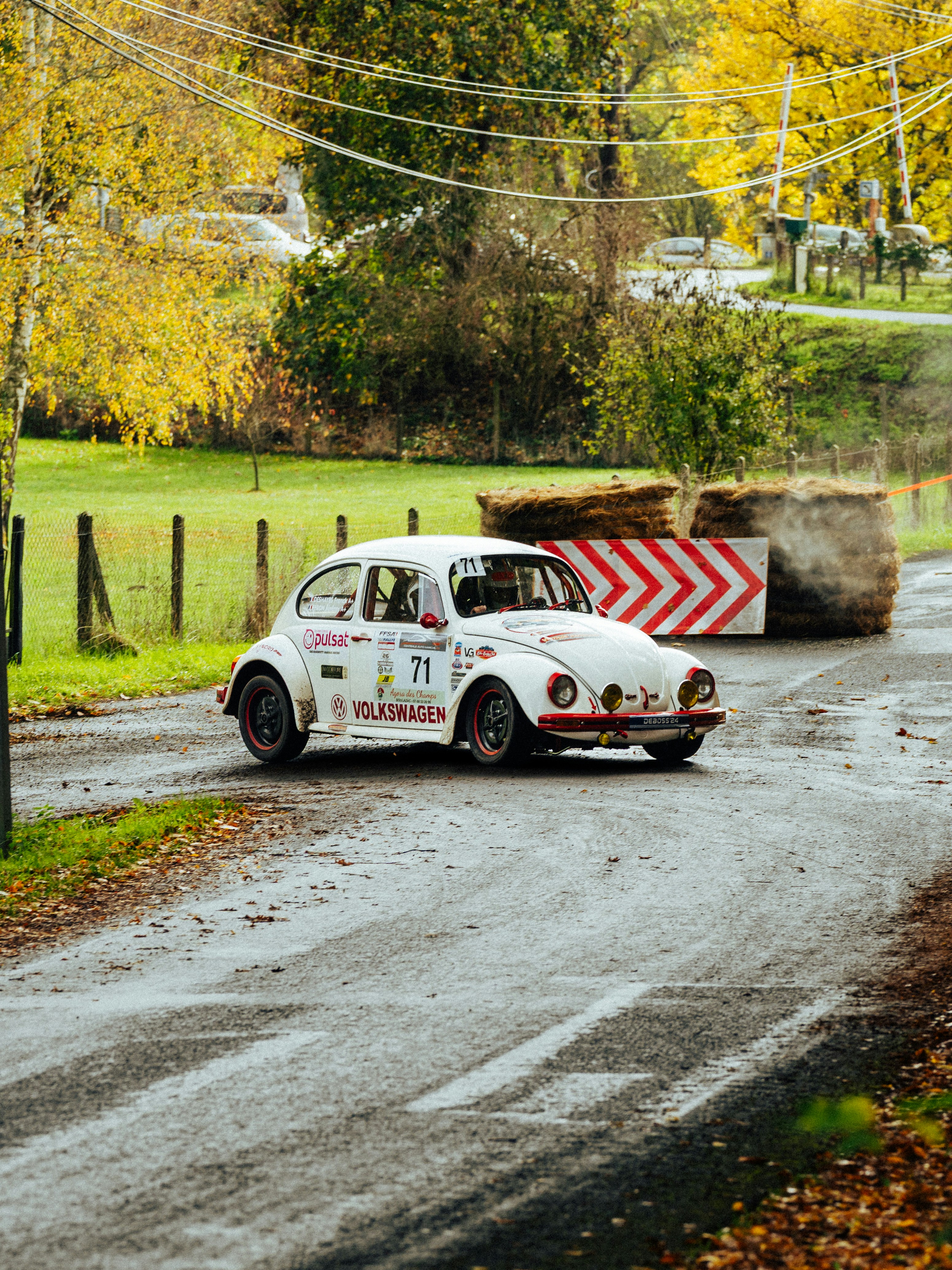 Autumn Rally Run: White VW Beetle Navigates a Rain-Slick Country Road