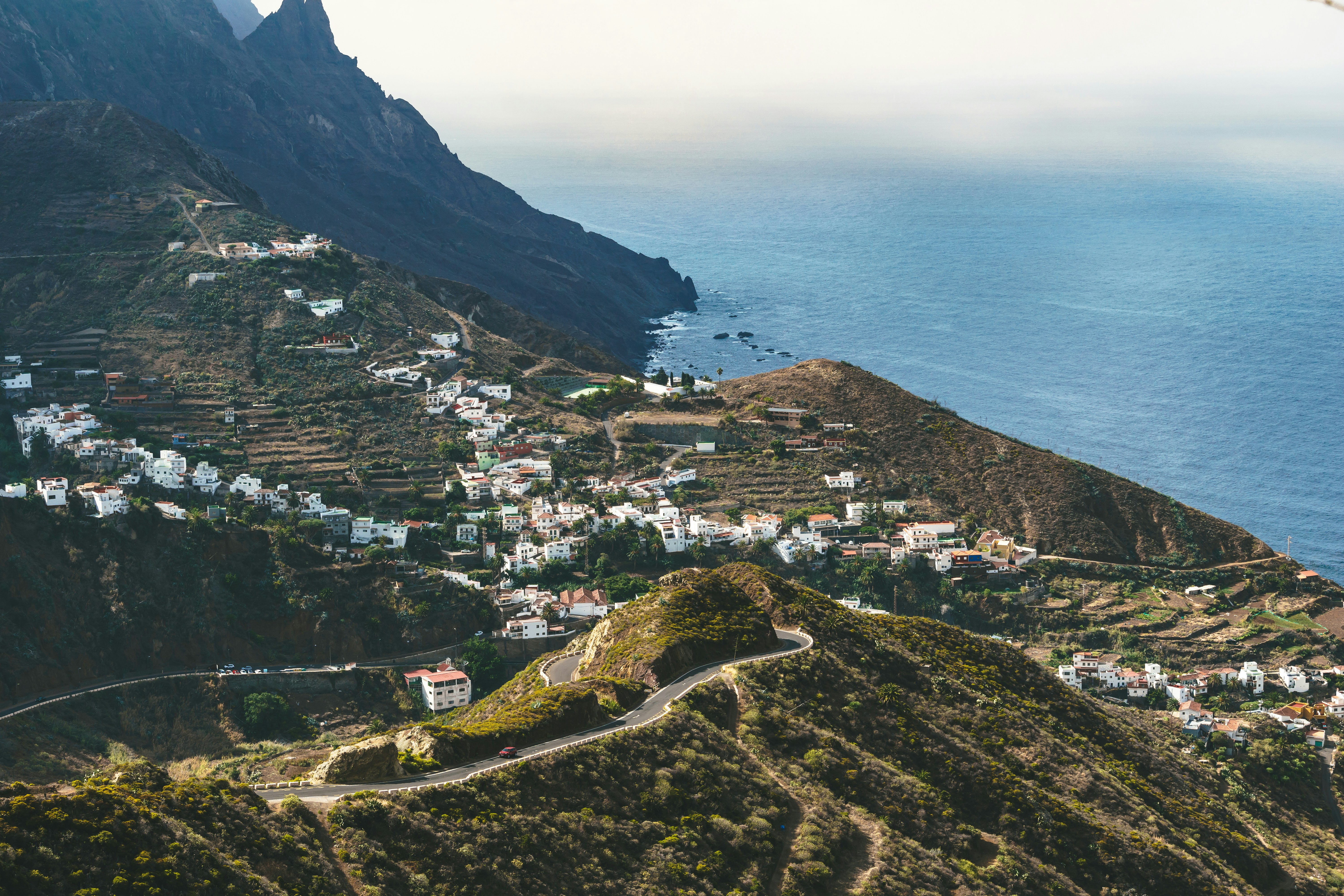 Terraced White-Washed Village Descends Toward the Sapphire Sea