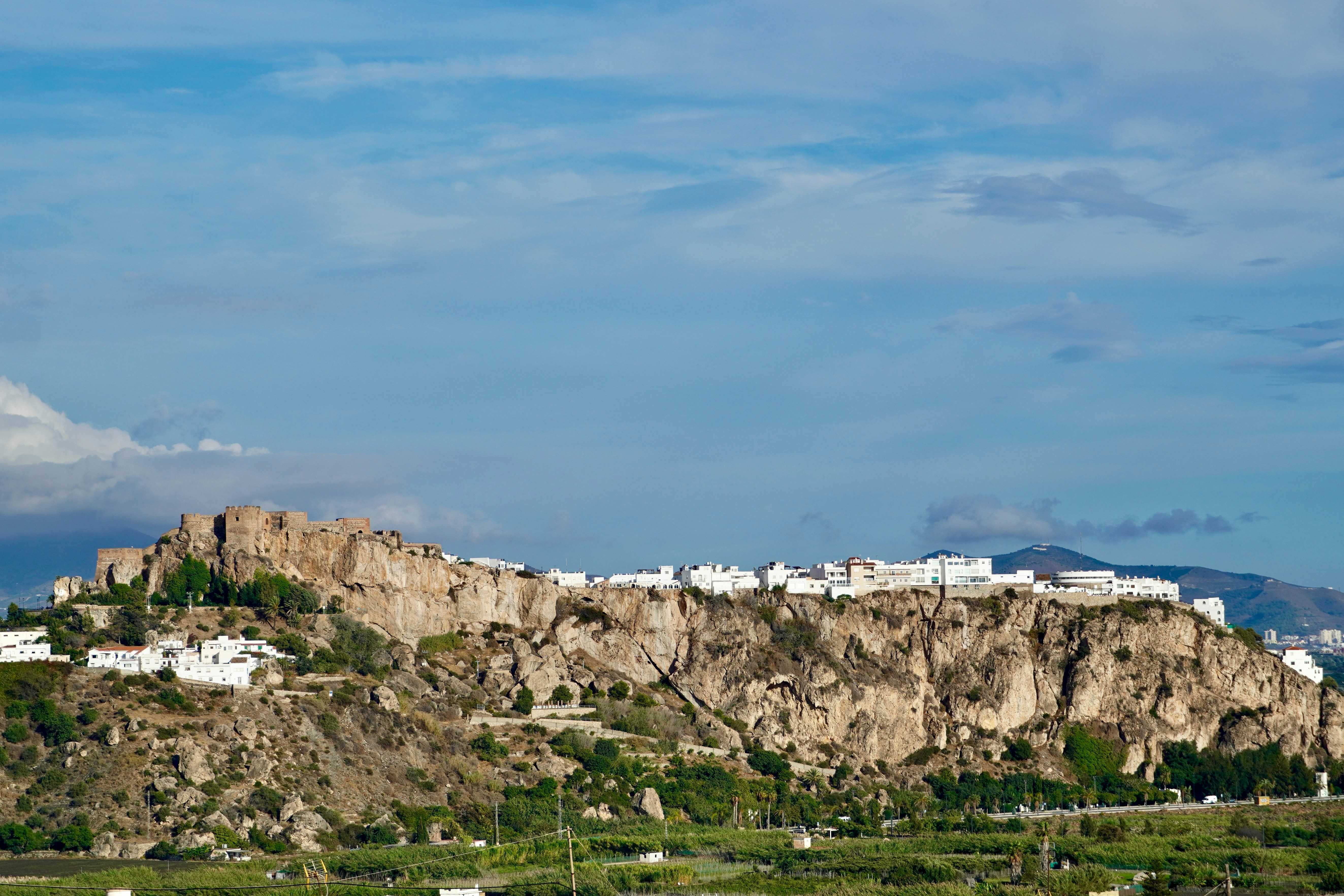 Cliff-top Ruin and Whitewashed Village Under a Mediterranean Sky