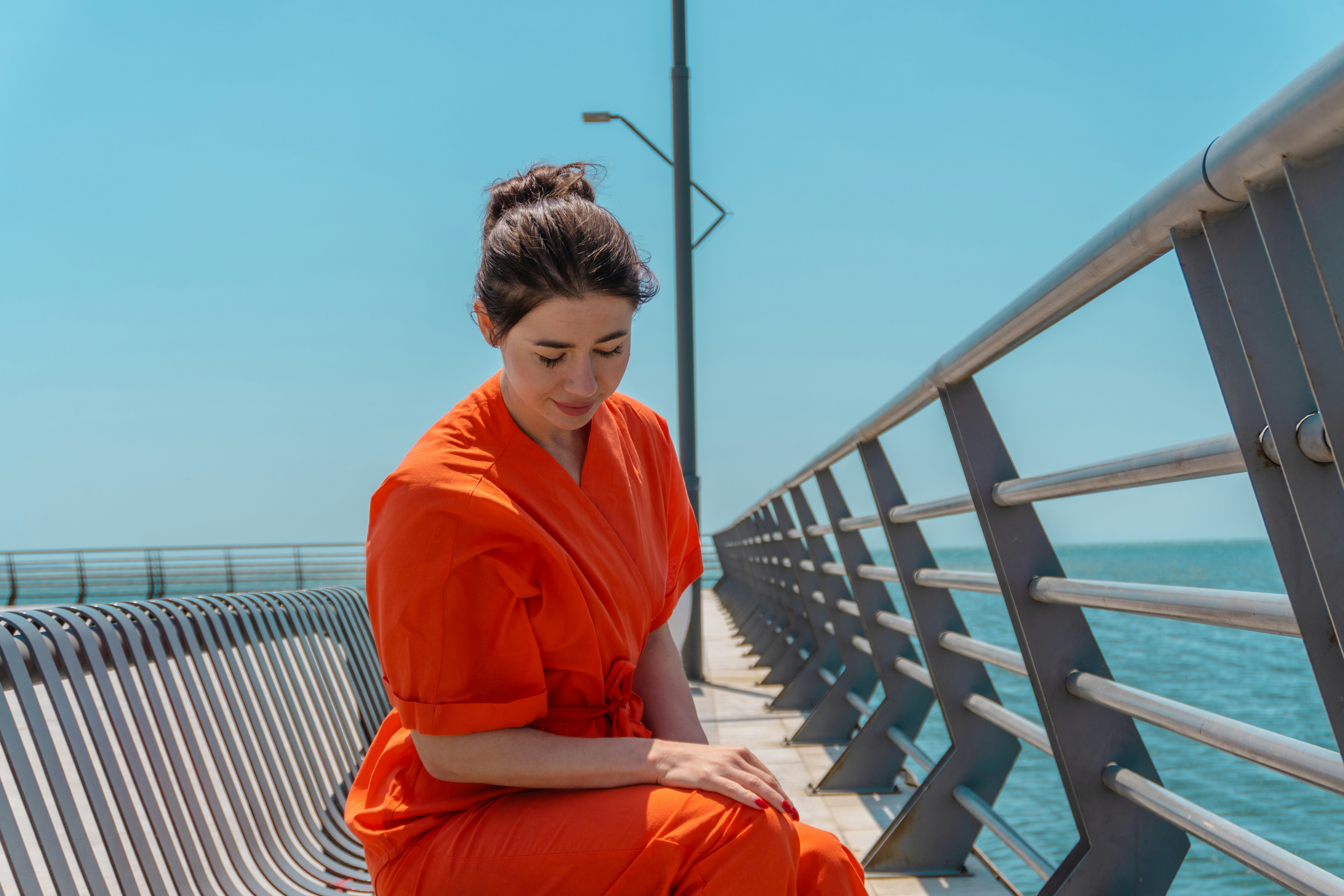 Orange at the Edge: Quiet Portrait on a Wind-Swept Pier