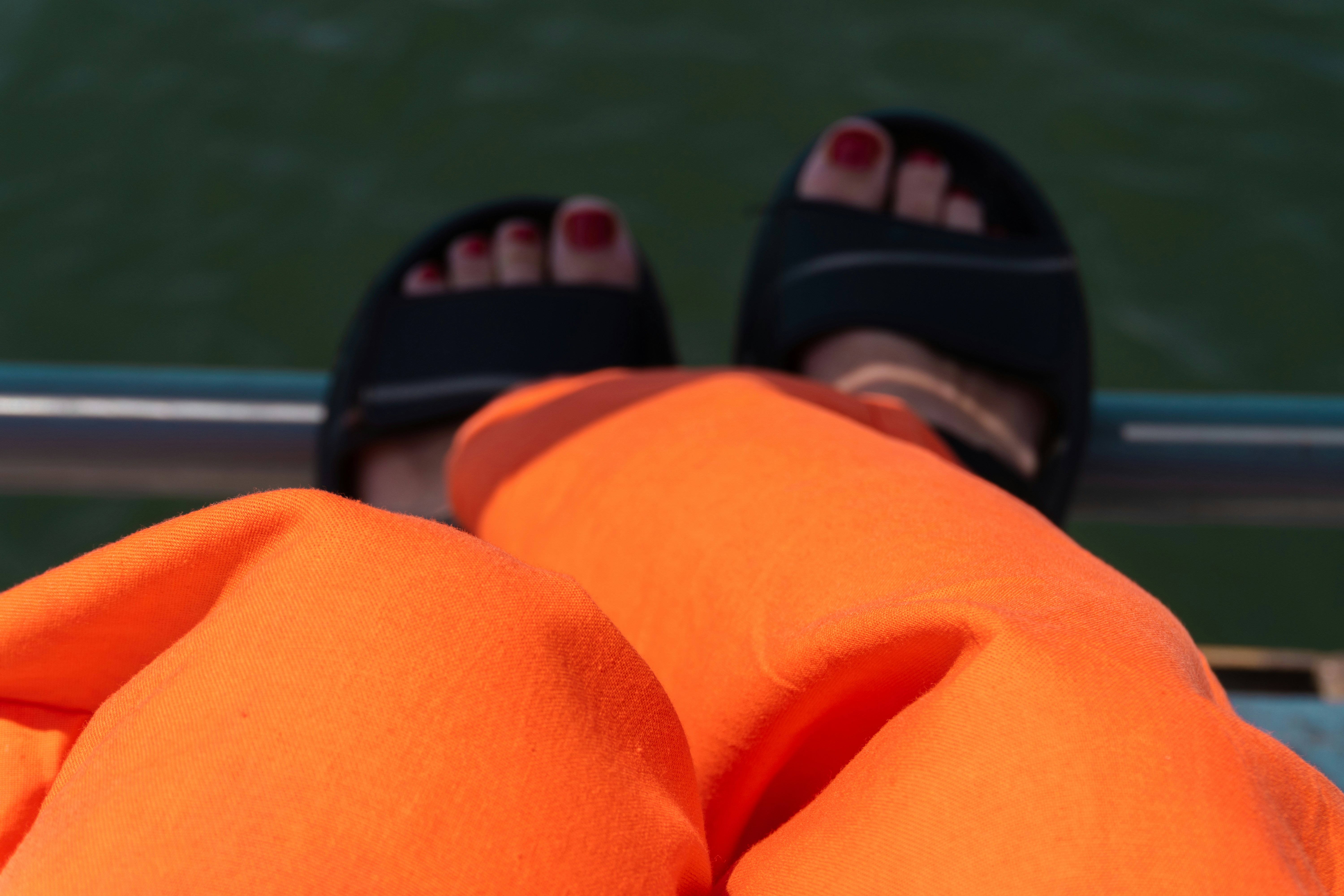 Orange Draped Foreground: Feet Above a Riverside Balcony