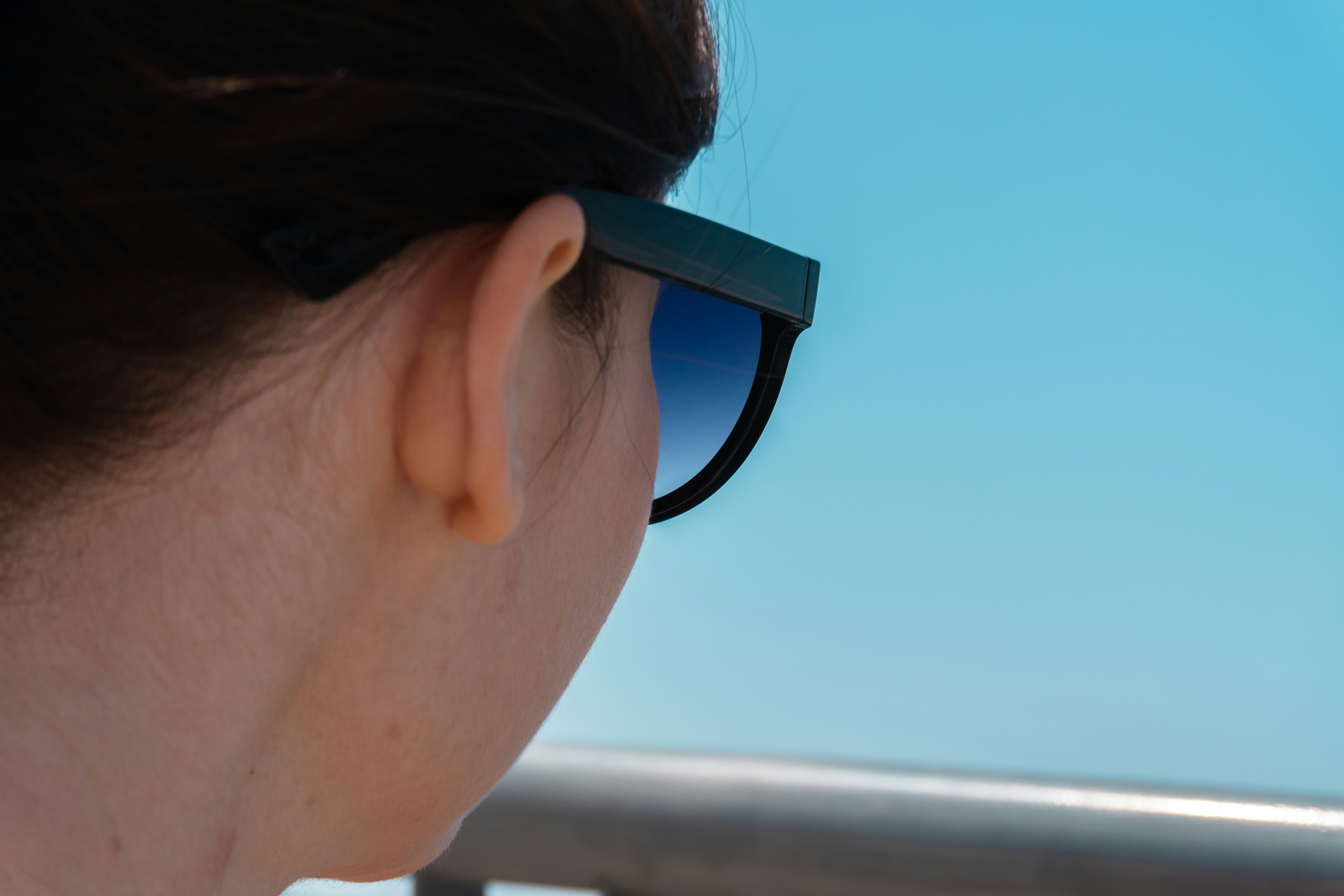 Woman wearing sunglasses looking at the sky