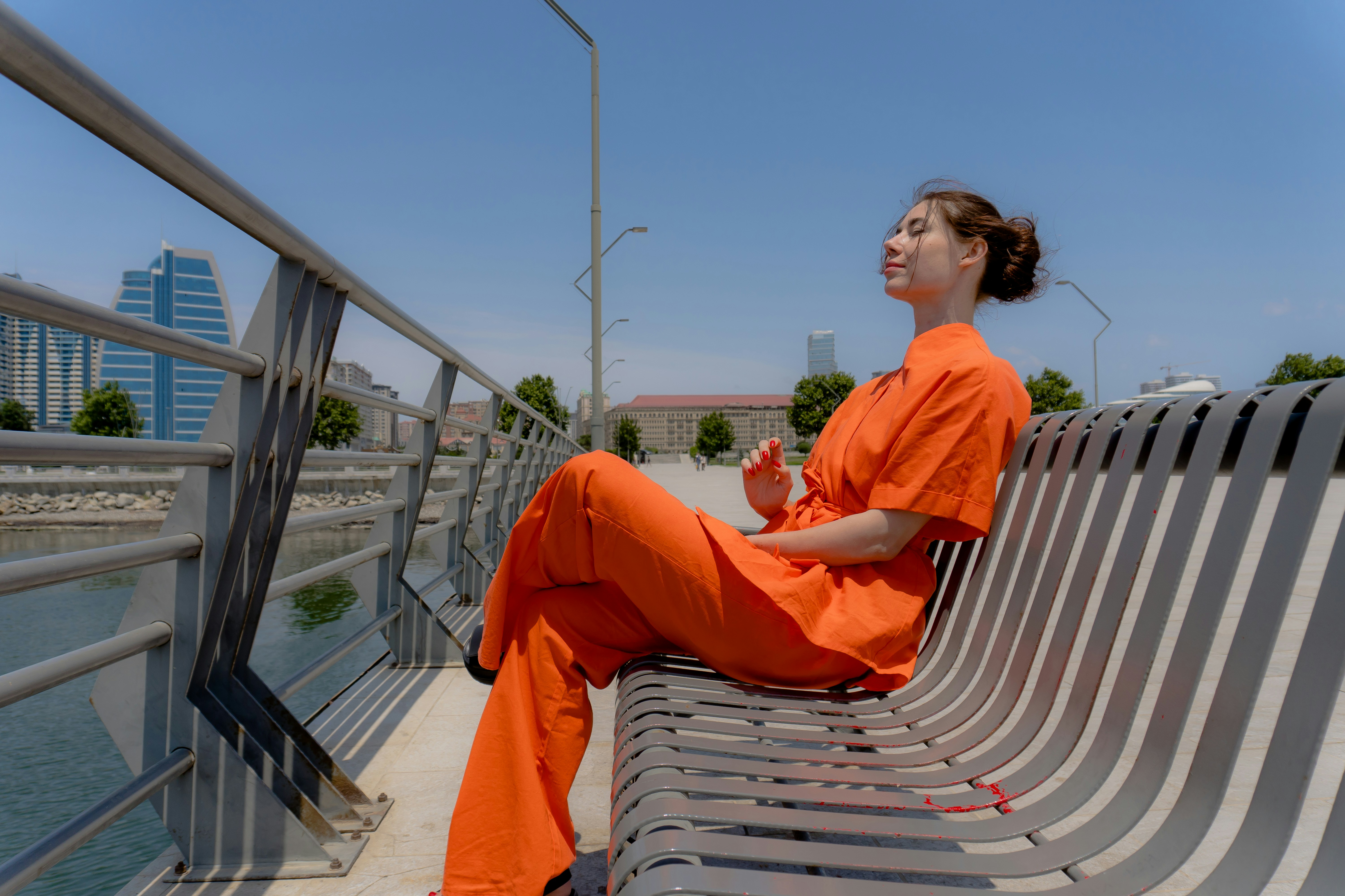 Crimson-Clad Quietude on a Modern Waterfront Bench