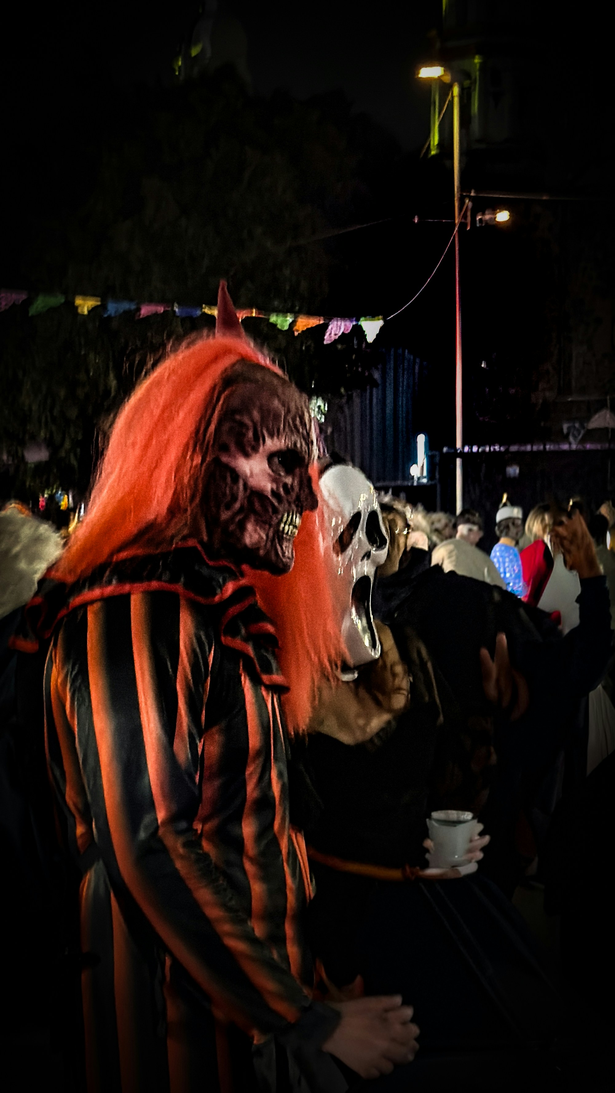 Crimson Masked Figure in a Neon Night Carnival