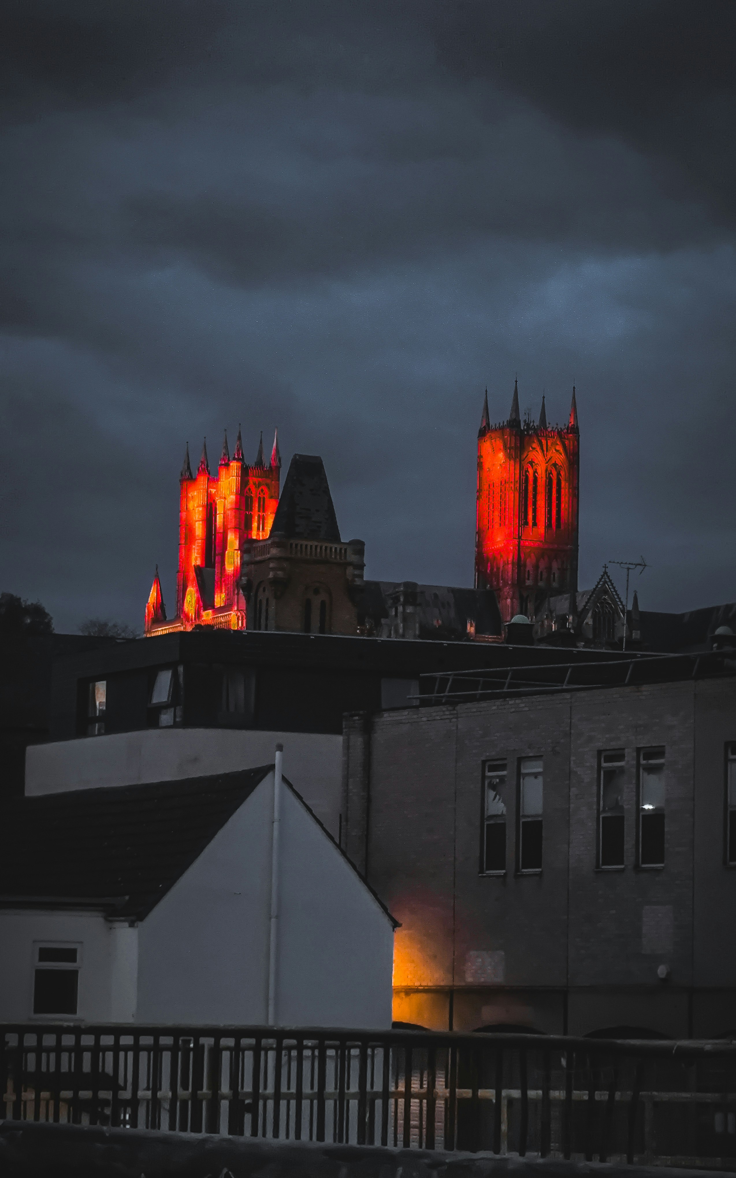 Lincoln Cathedral | Gothic cathedral illuminated with red light at dusk.