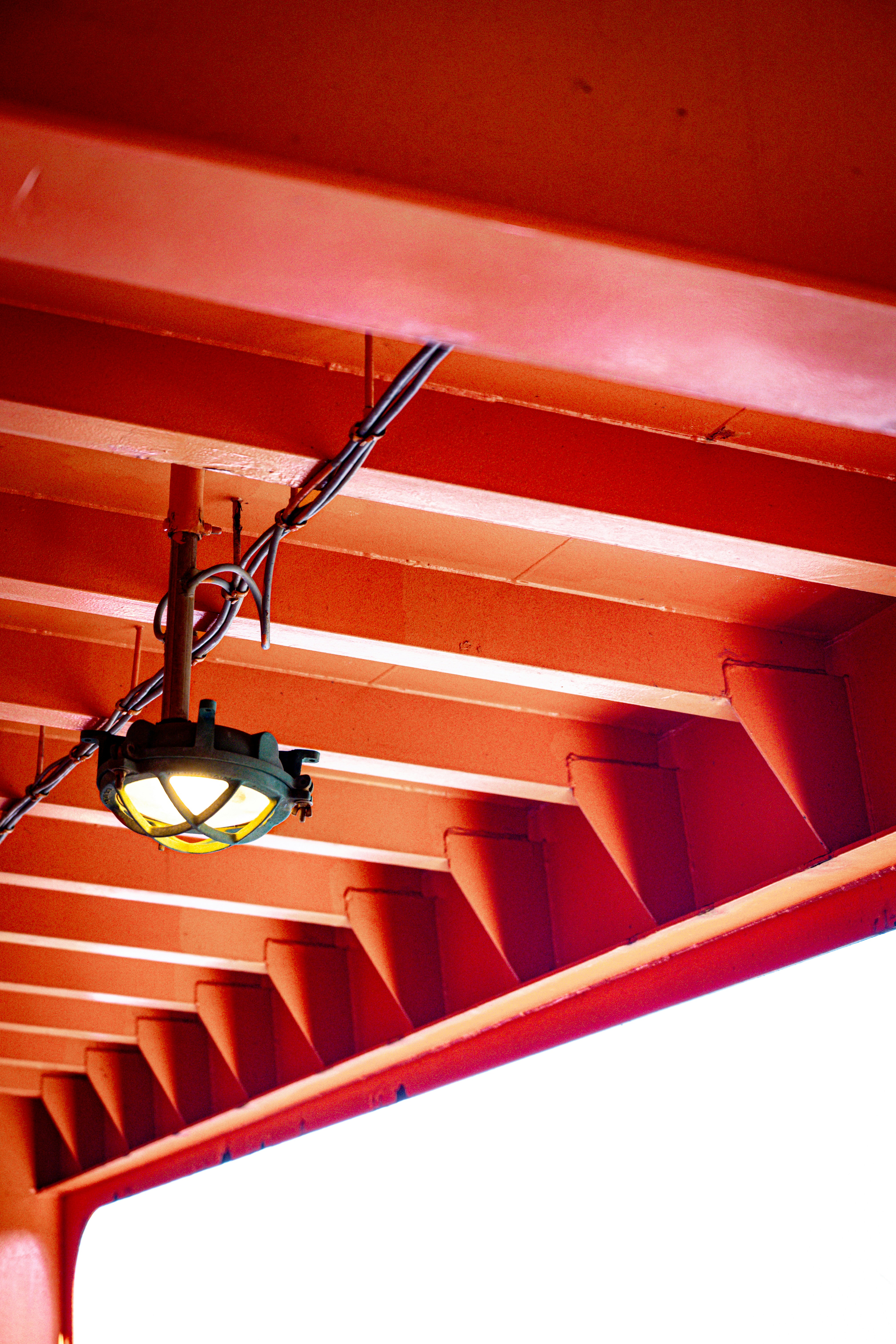 Crimson Truss Lantern: A Lone Light Under the Bridge