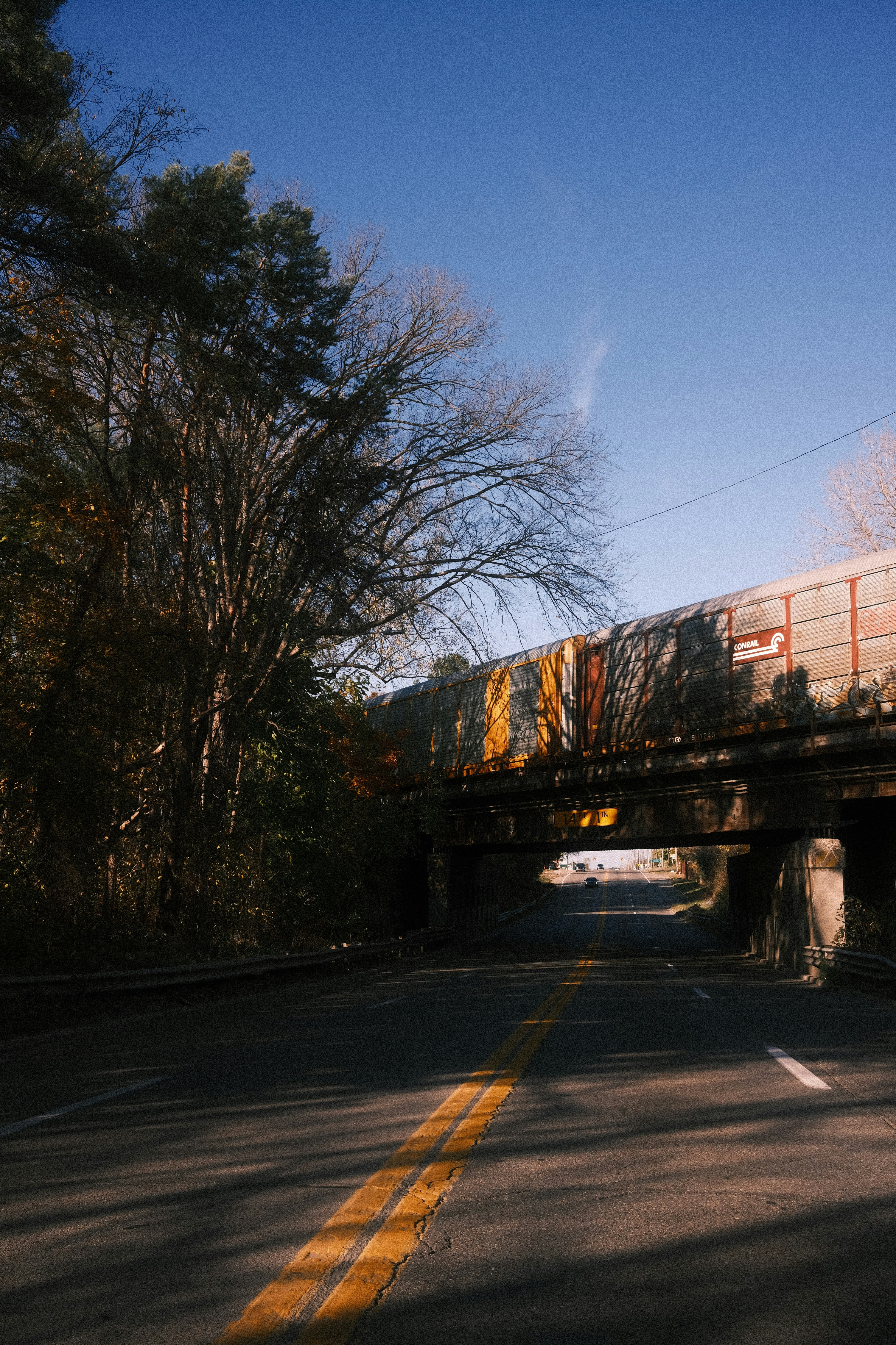 Road passes under a graffiti-covered overpass
