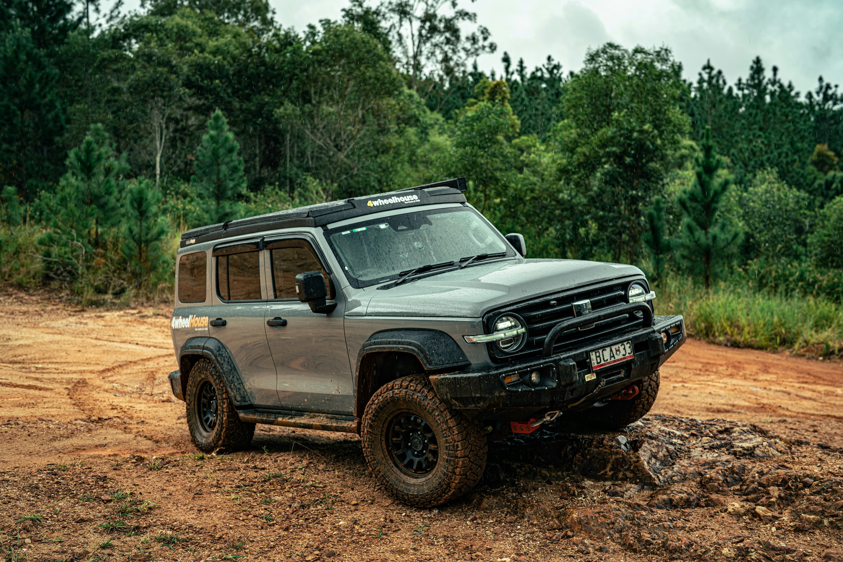 A GWM Tank photographed on a muddy trail after a Queensland downpour. This tough SUV embodies the next generation of Australian off-road capability and design.