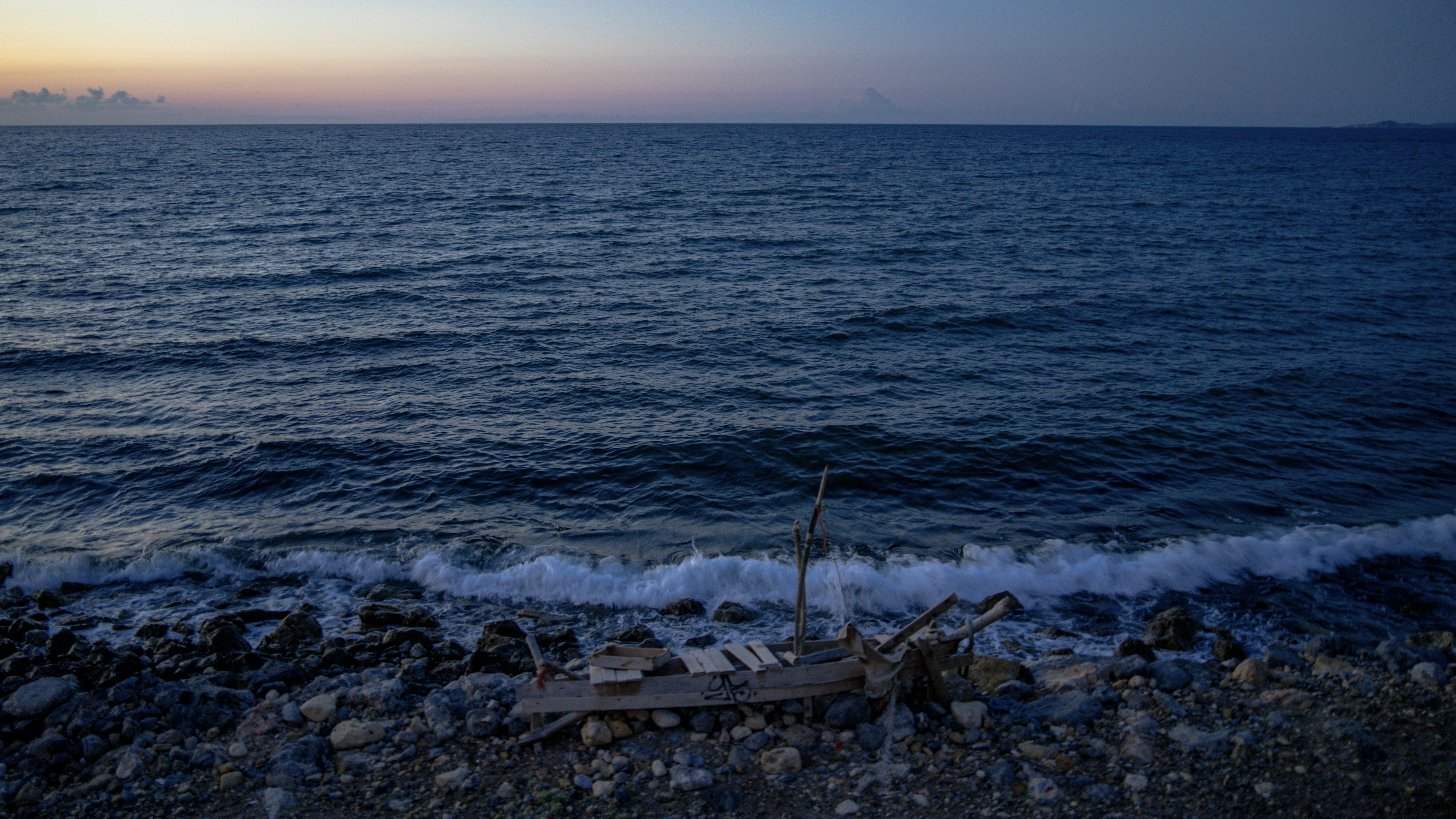 Driftwood Relic at Dusk on a Pebble Shore