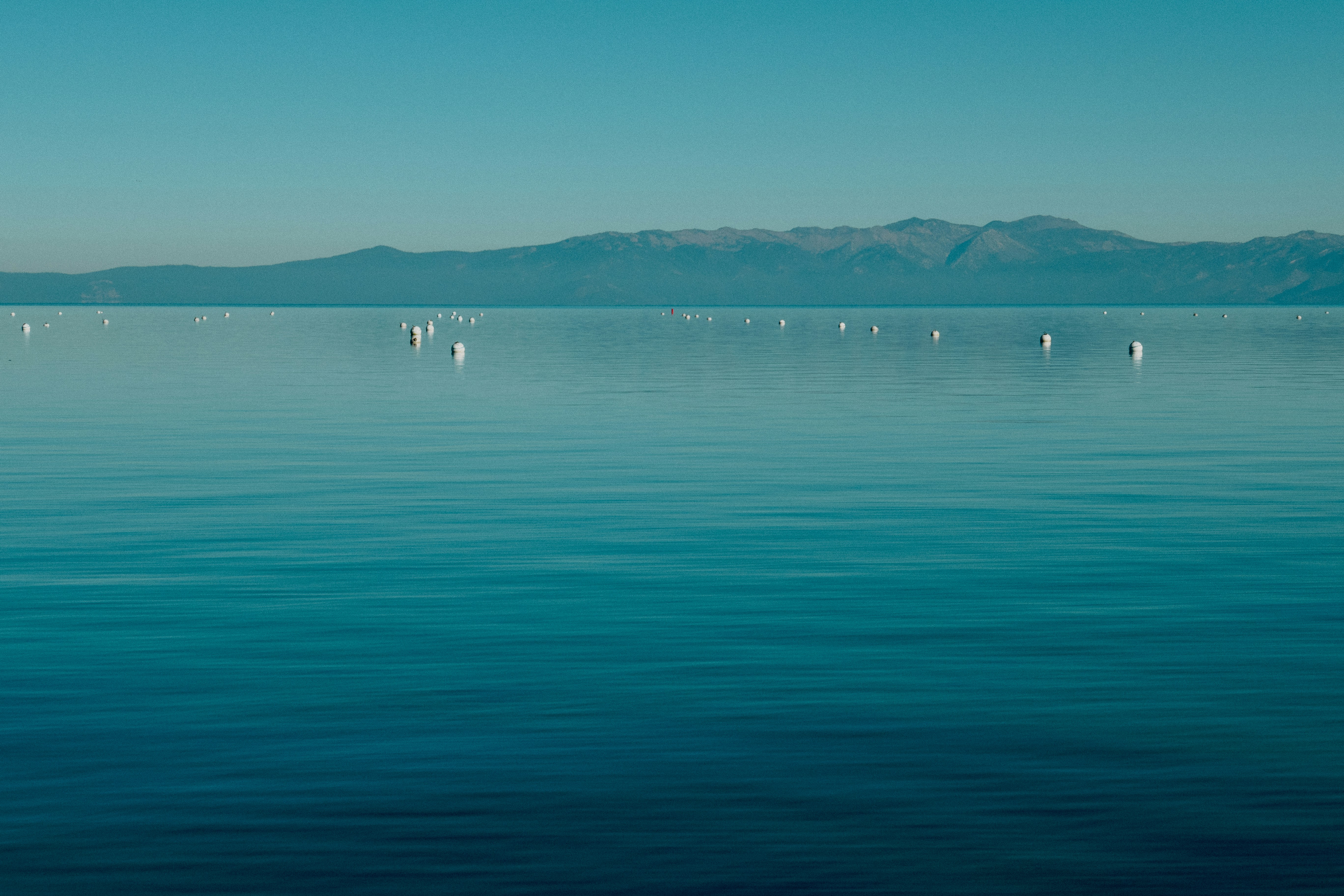 Calm blue water with distant mountains on horizon