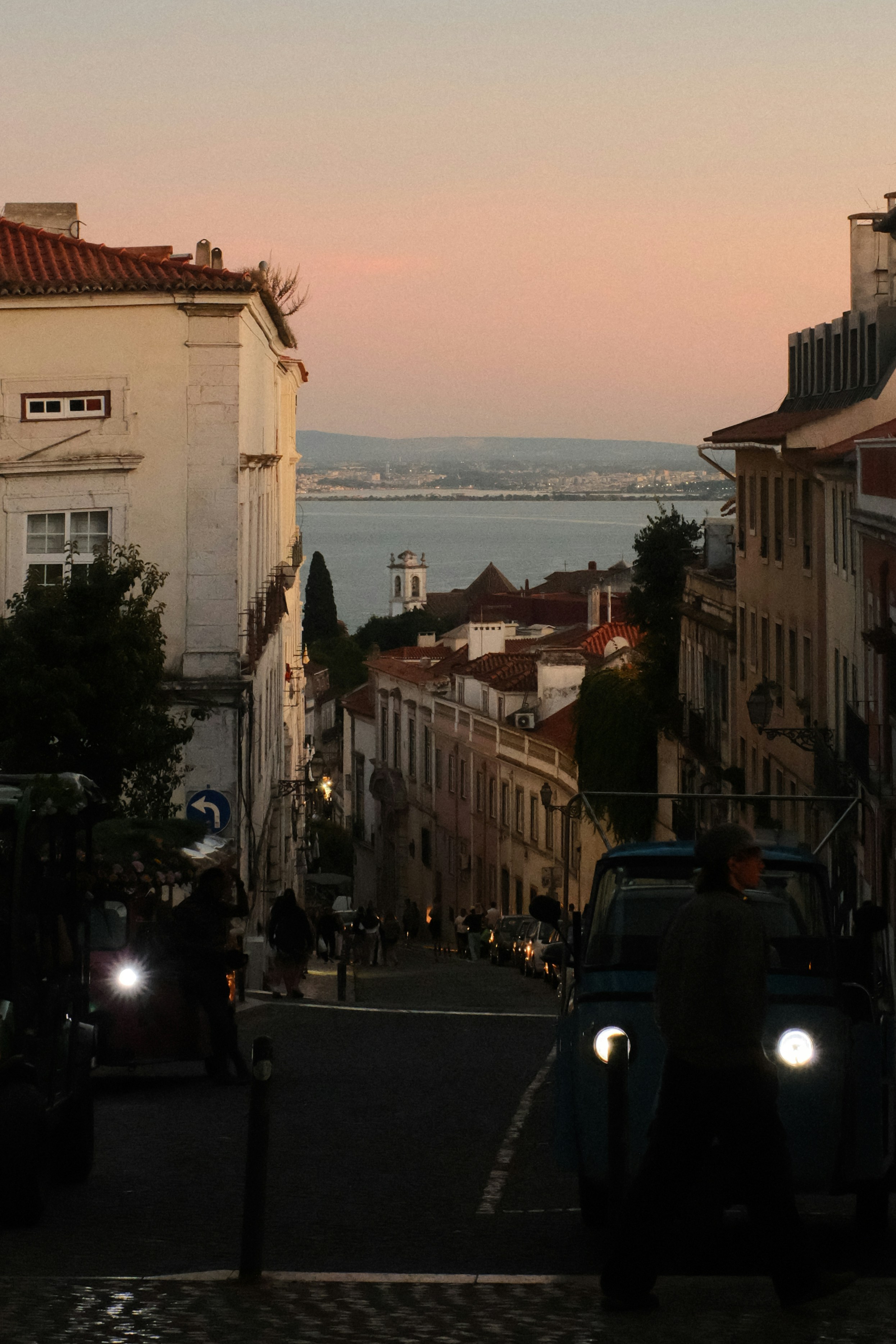 Golden Hour Descent: A Sloped Street Framing the Sea at Dusk
