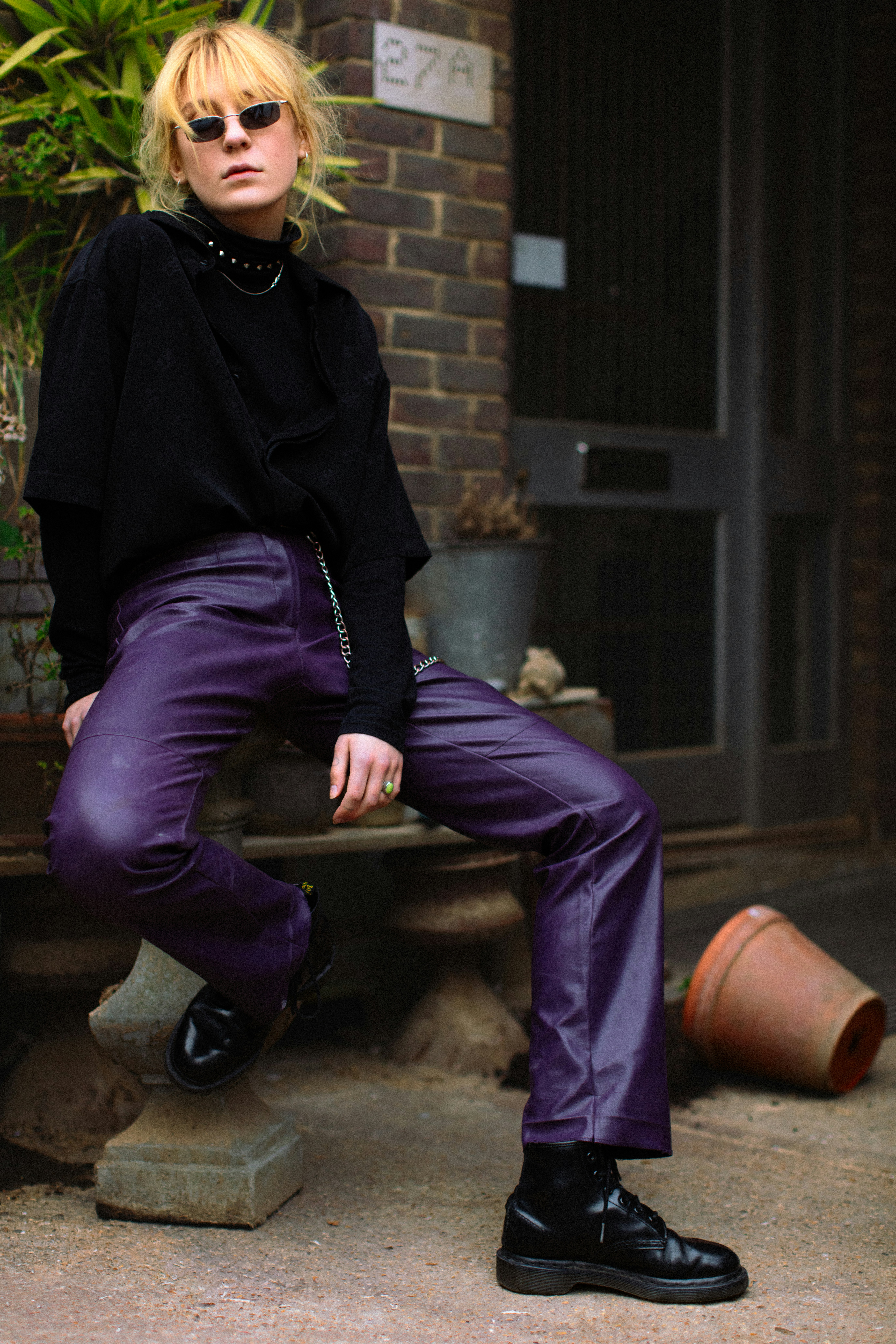Stylish woman in purple pants posing outdoors