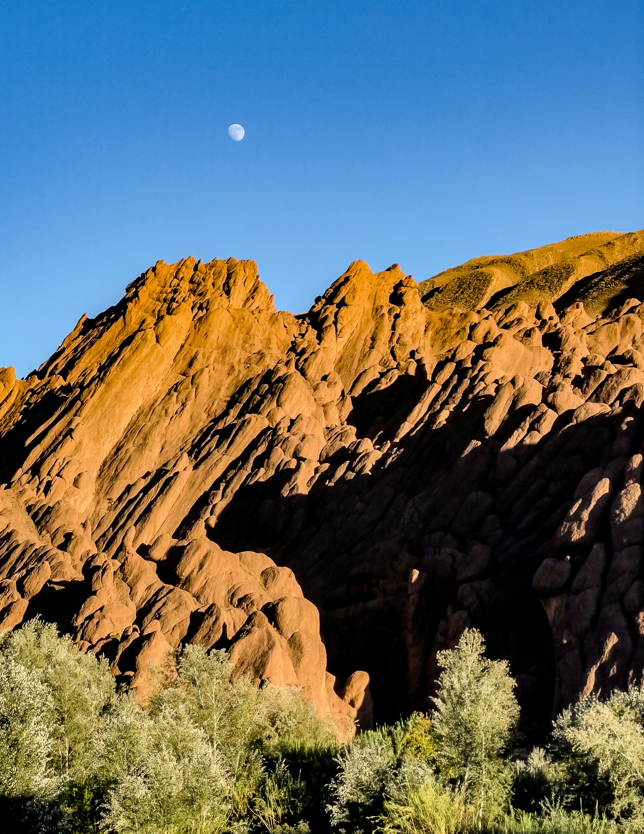 Red rock formations under a clear blue sky.