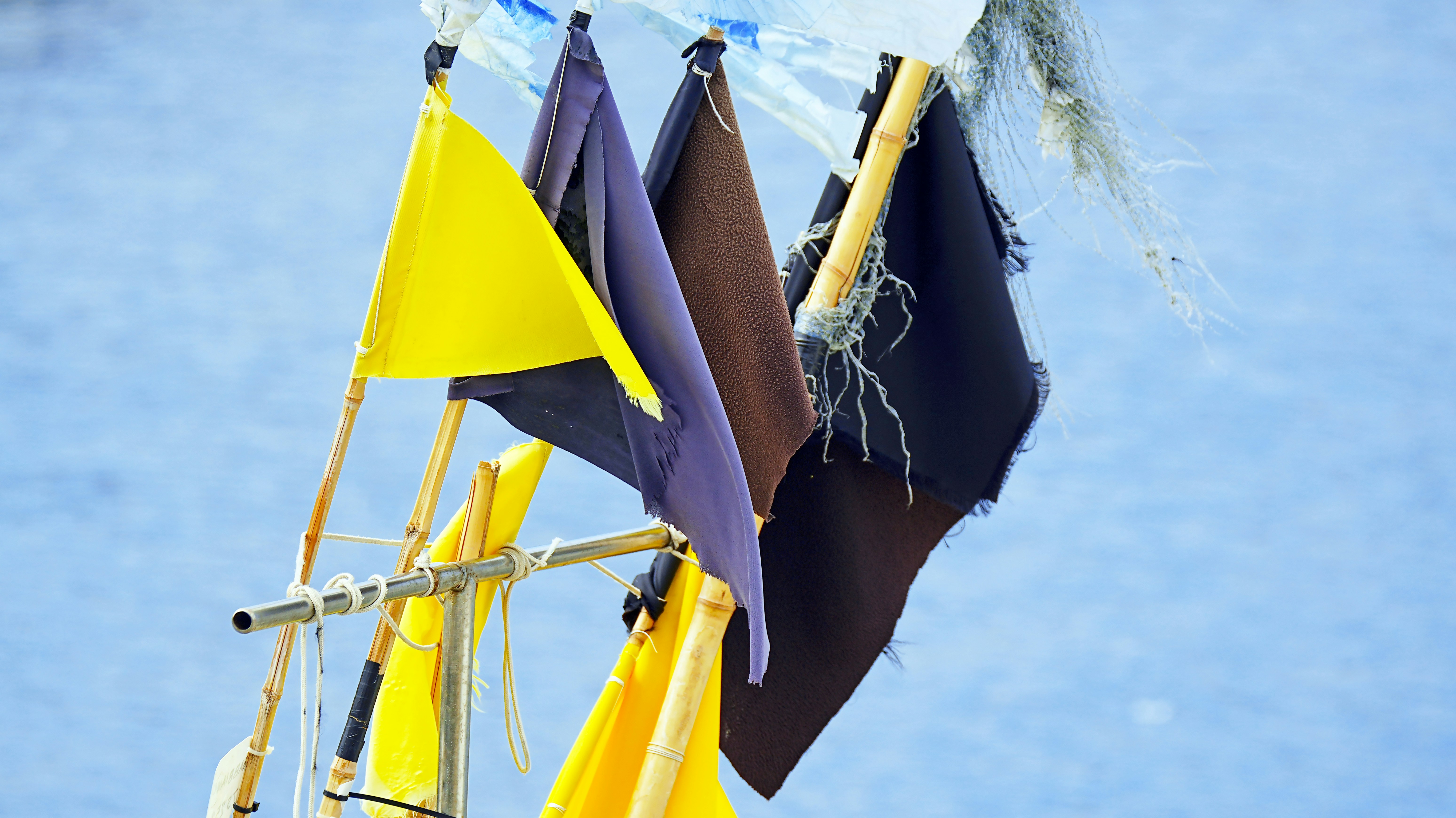 Flagline Over Quiet Blue: Triangles Draped Above the Sea