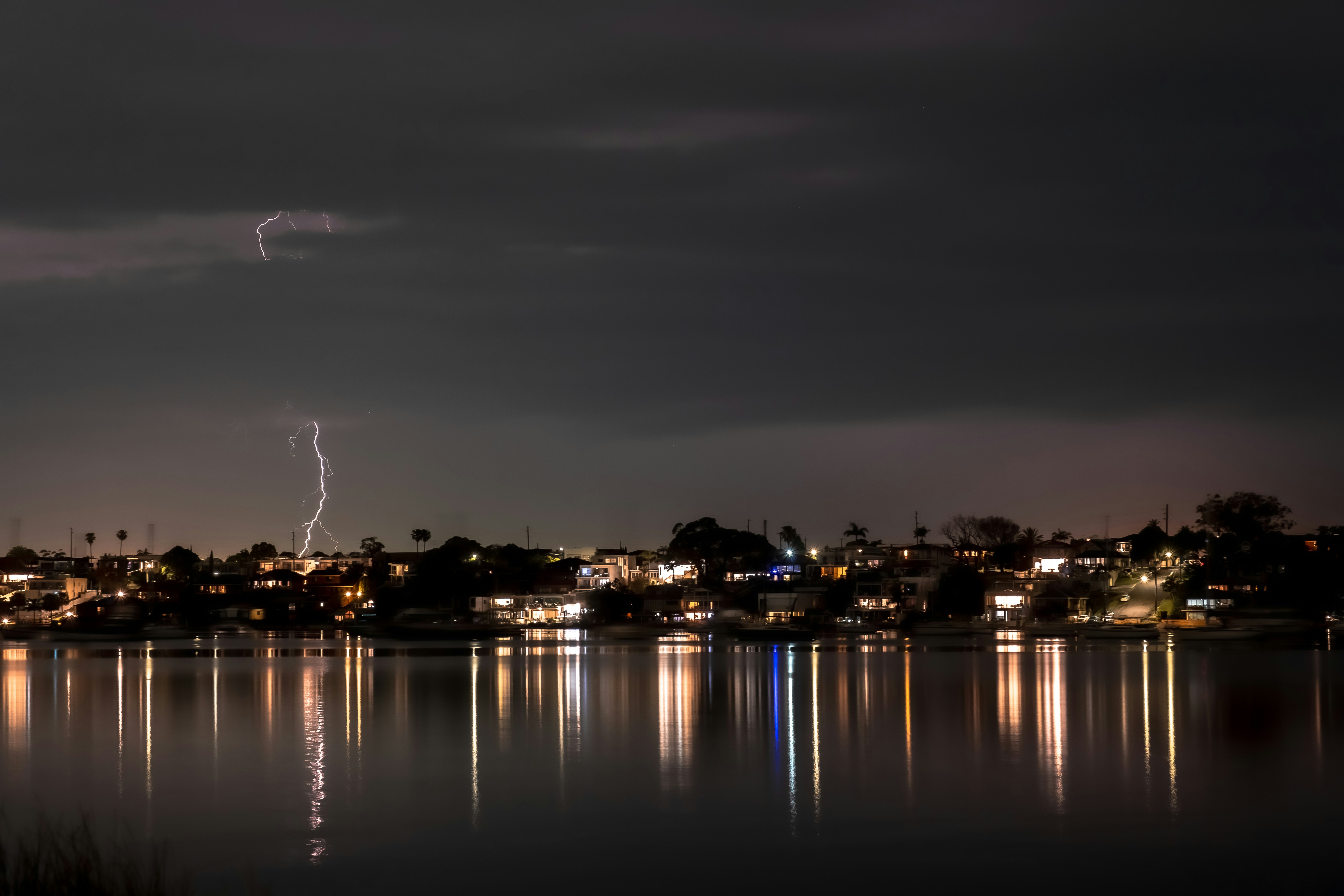 Harbor Lightning over Quiet Reflections