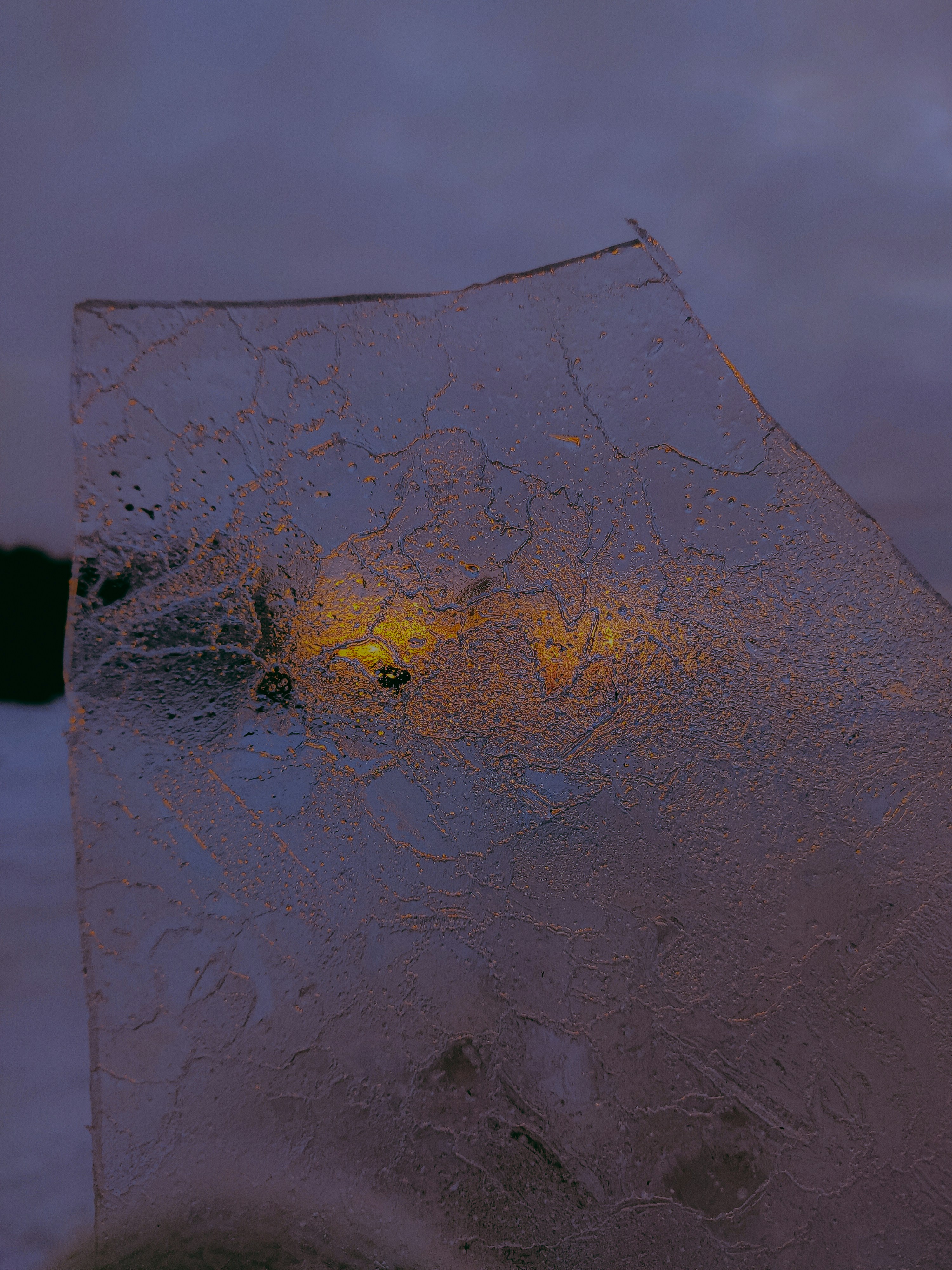 Backlit Ice Prism: Warm Ember Through a Dusk-Blue Crystal