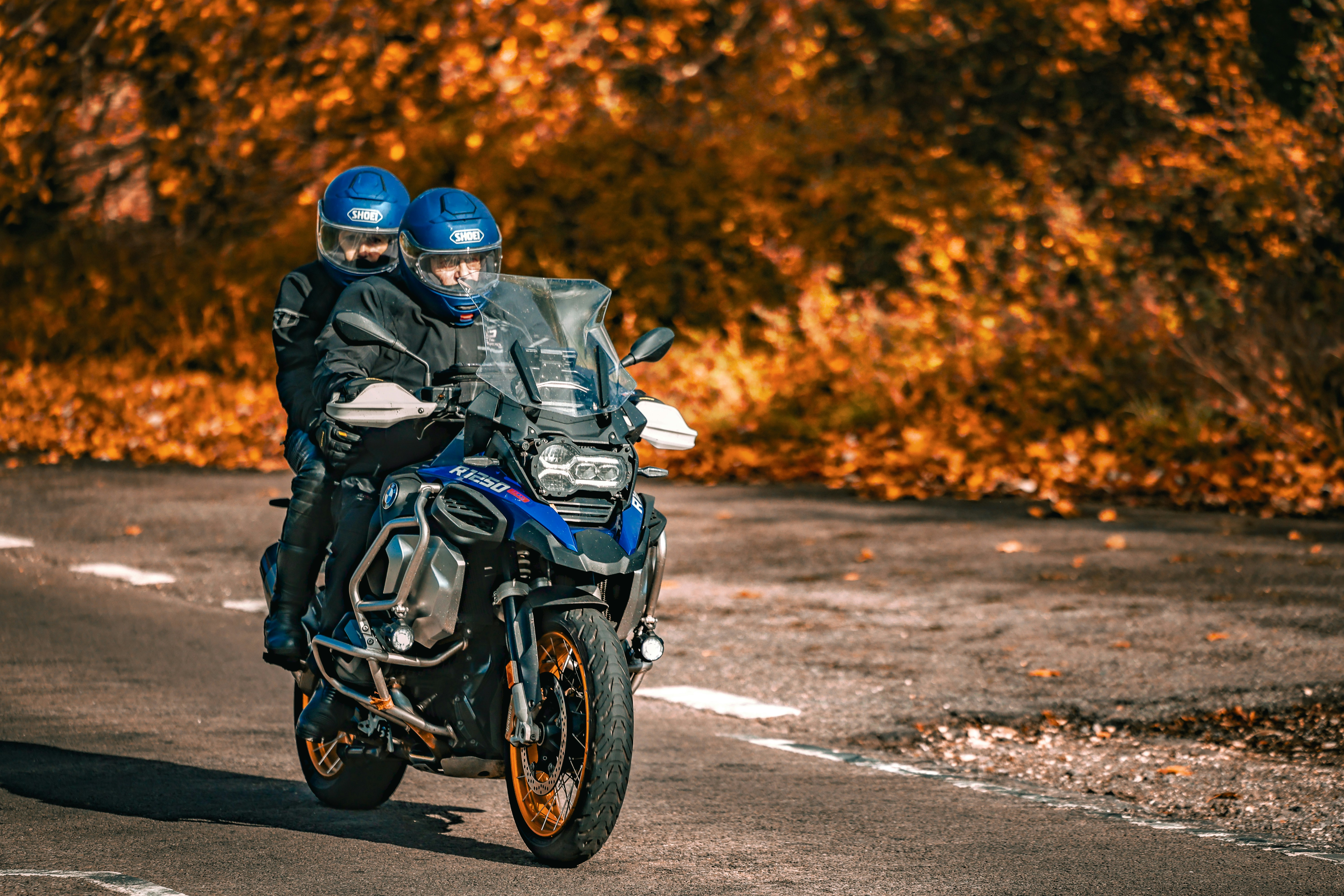 Autumn Patrol: Dual-Helmet Duo on a Blue Adventure Through Amber Roads