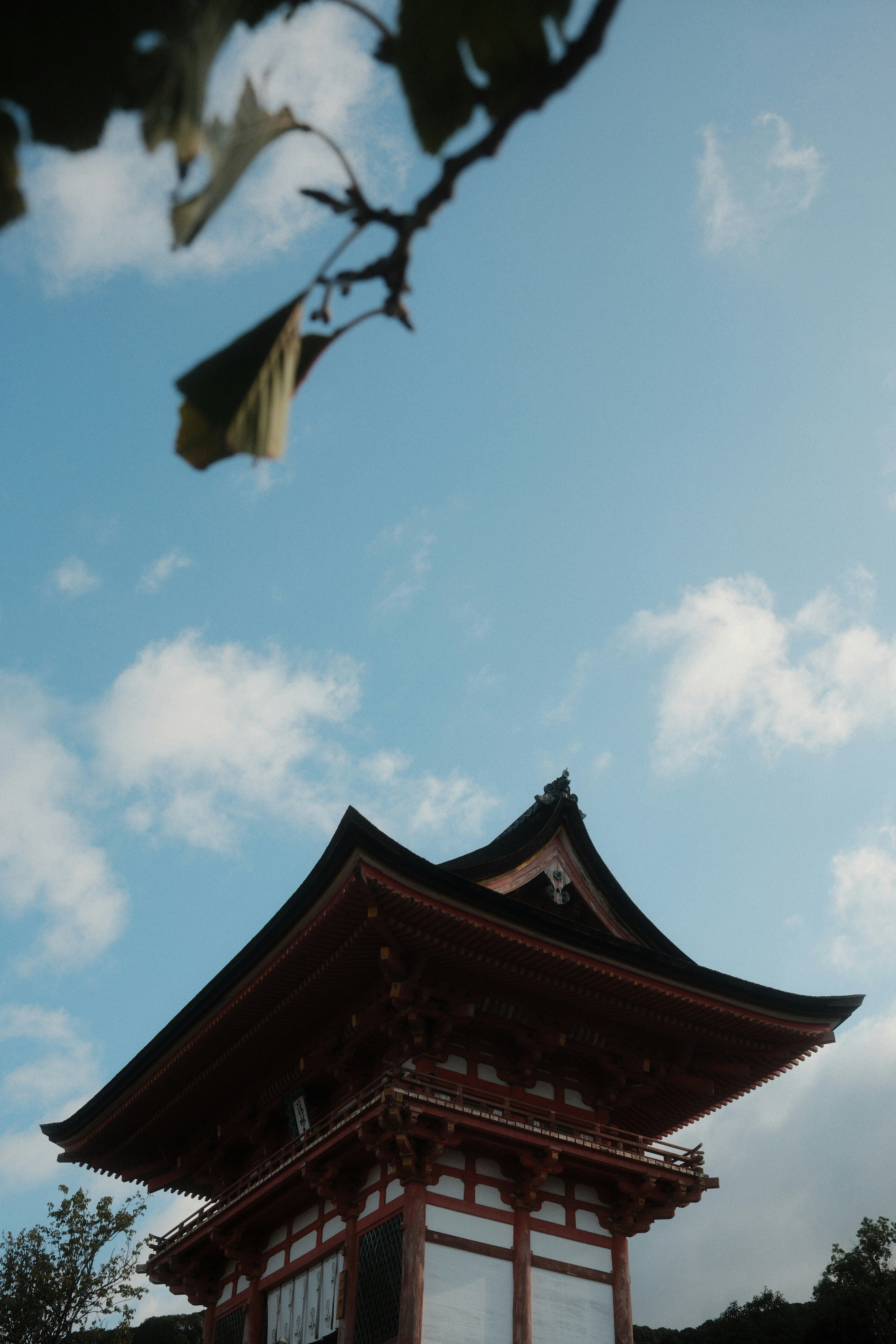 Red Timber Pagoda Beneath a Vast Blue Sky