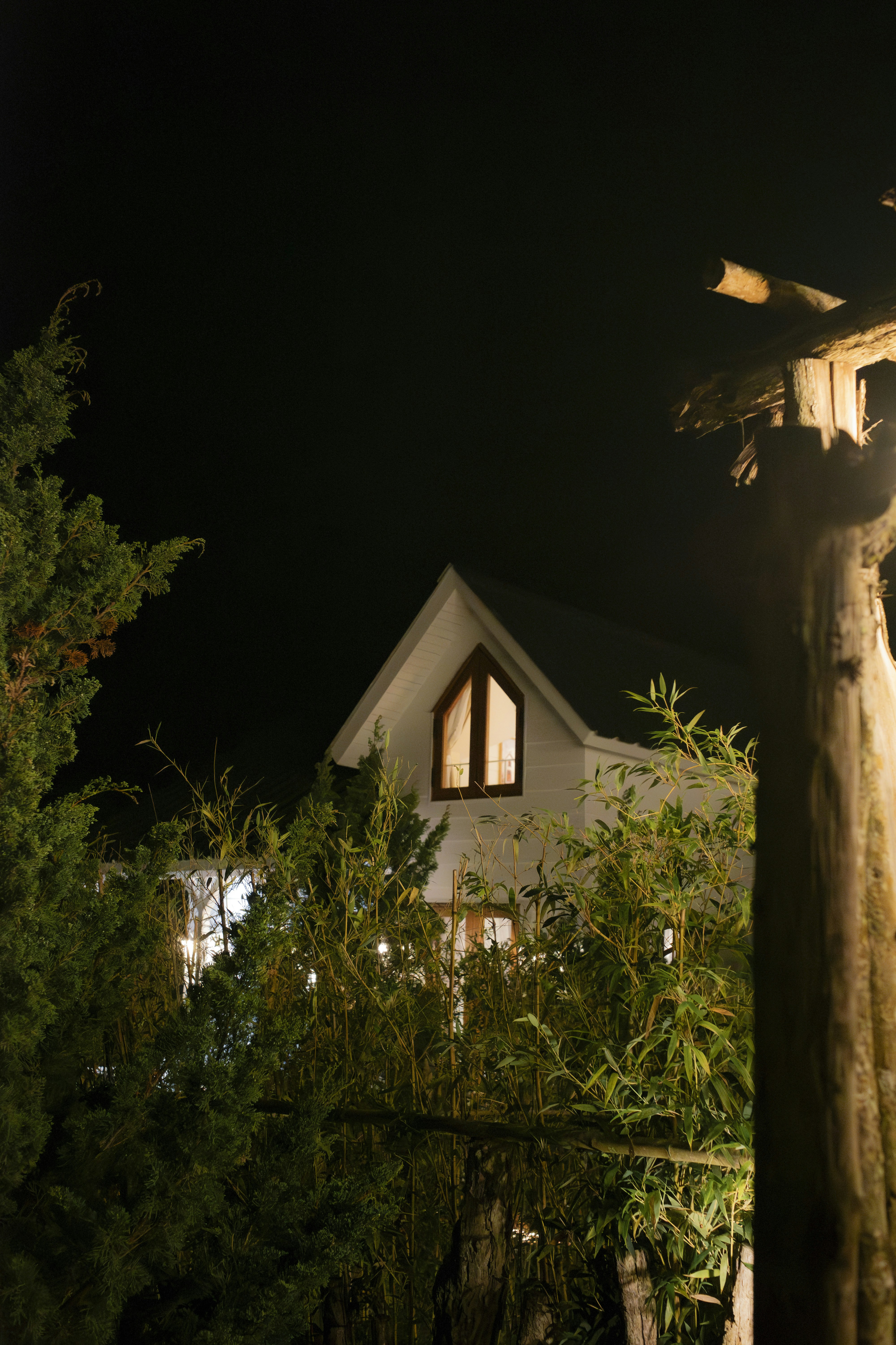 The Quiet Glow of a Bamboo-Framed Cottage at Night