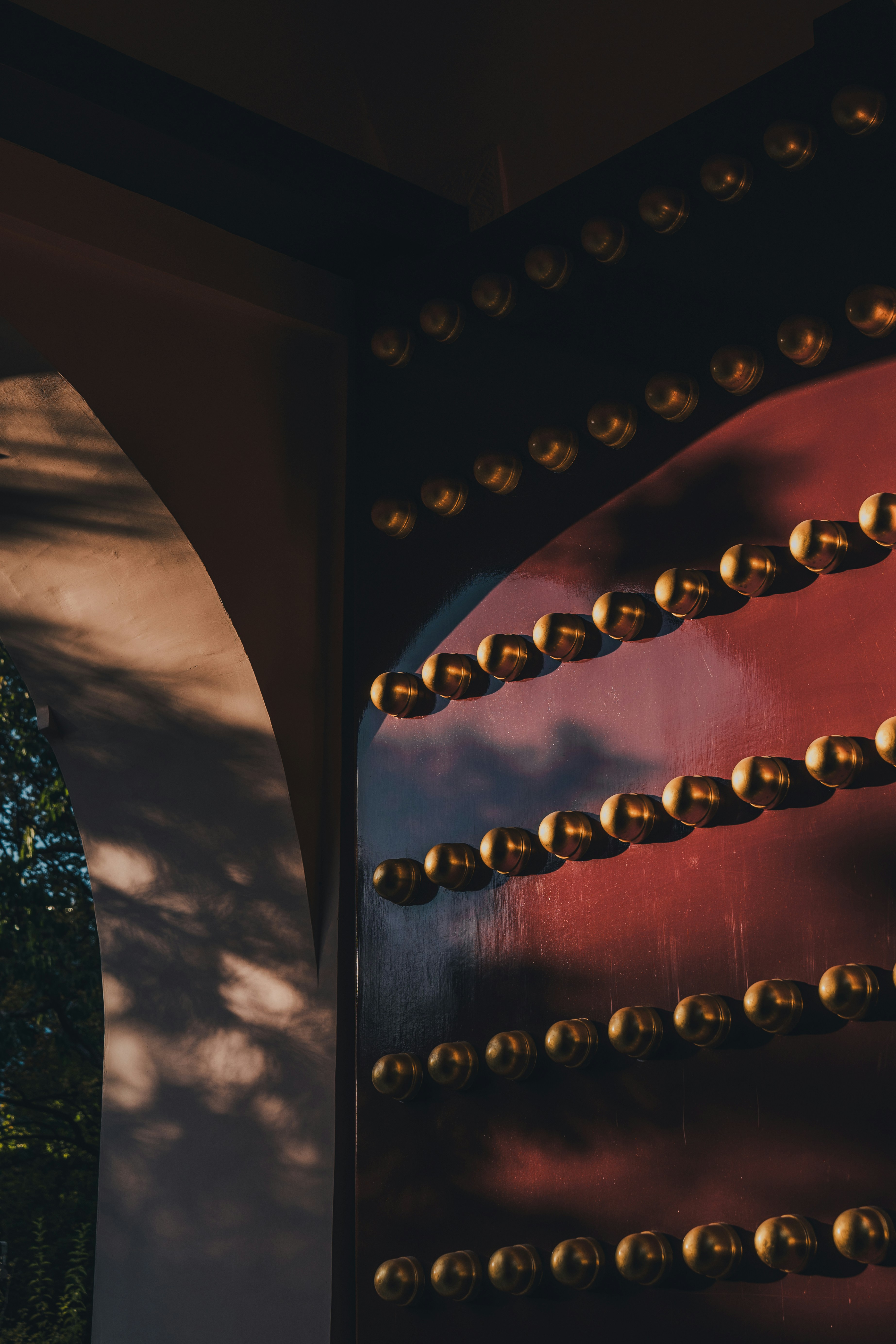 West Gate of Ritan Park | Red wooden door with ornate golden studs