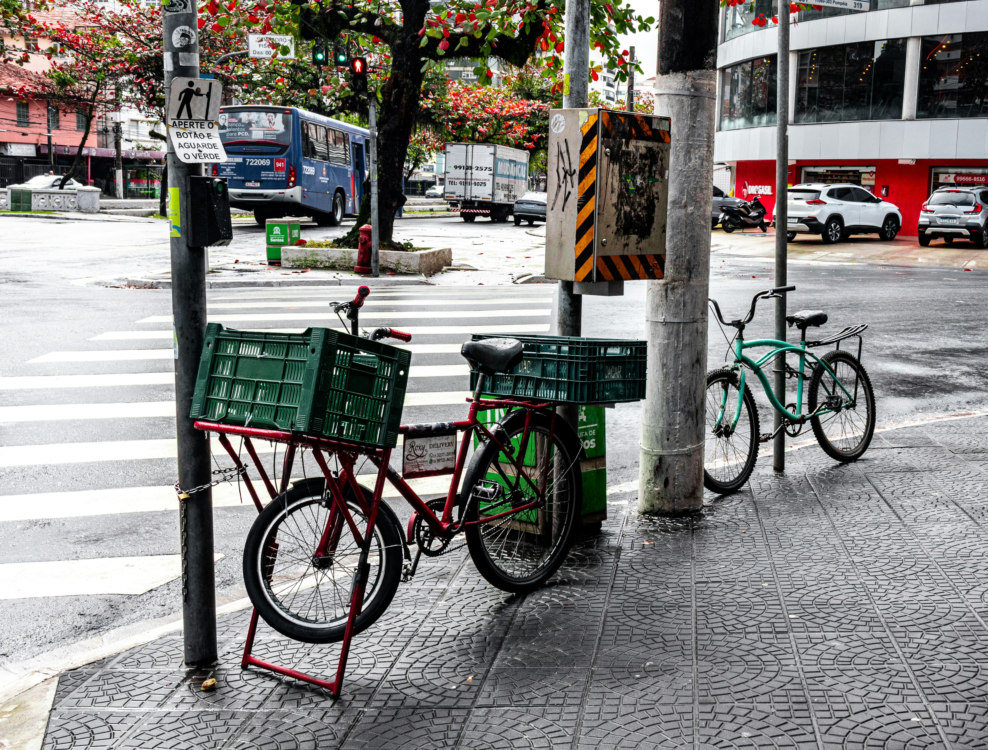 Anchored Cargo Bicycles by a City Crosswalk Amid Urban Detail