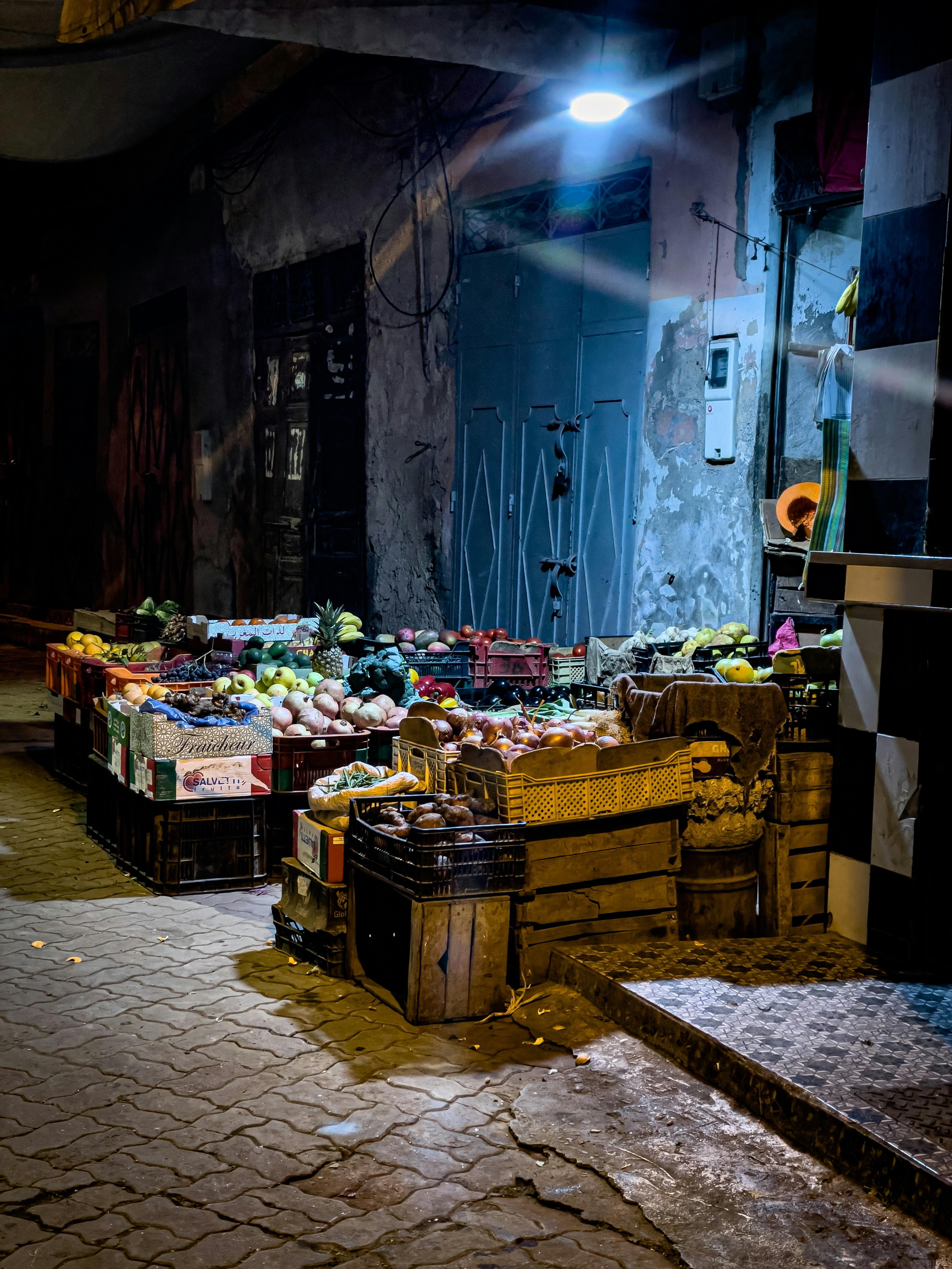 Fruit stand in a narrow alley at night
