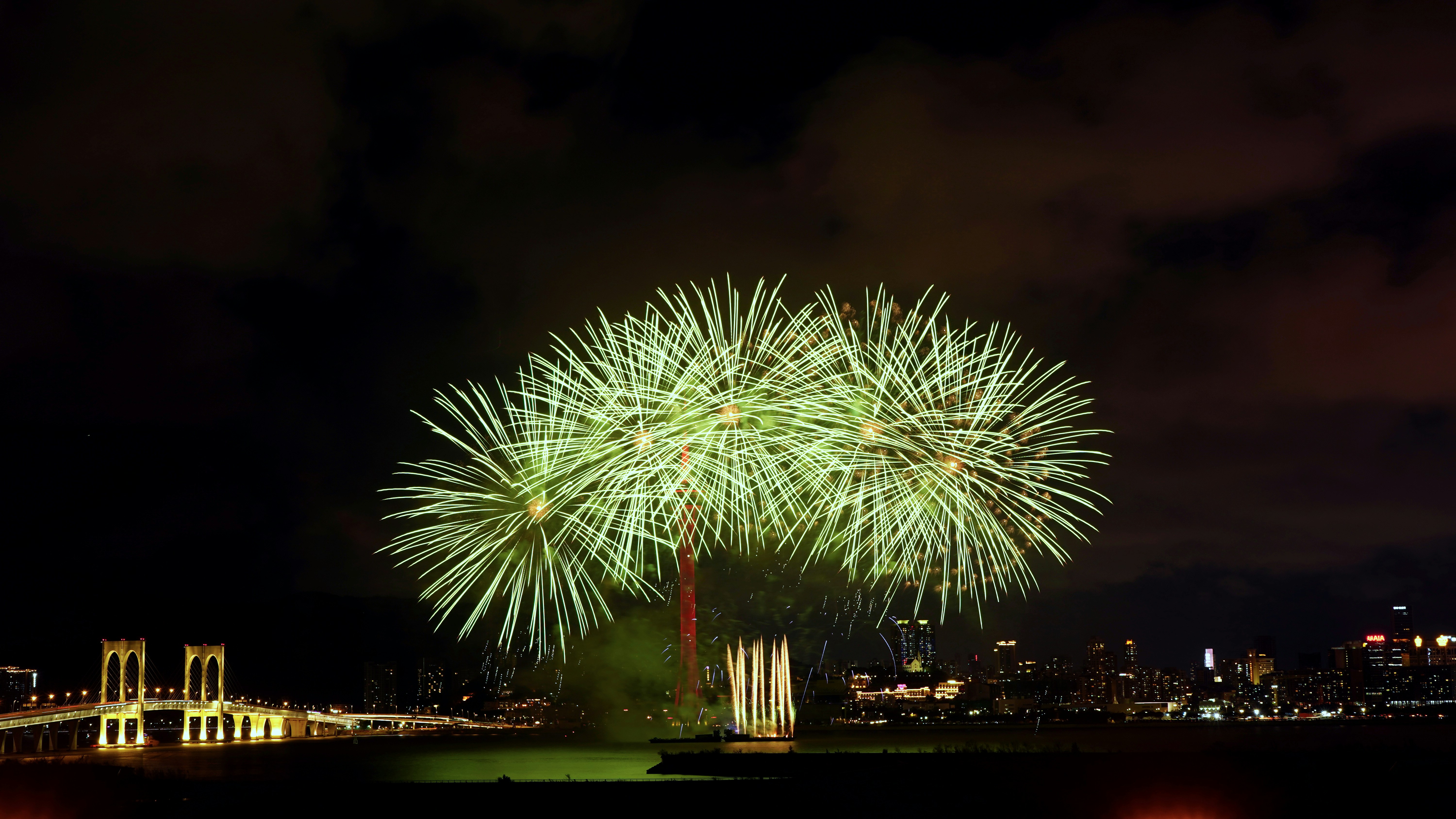 Emerald Fireworks Bloom Over the Riverfront Skyline