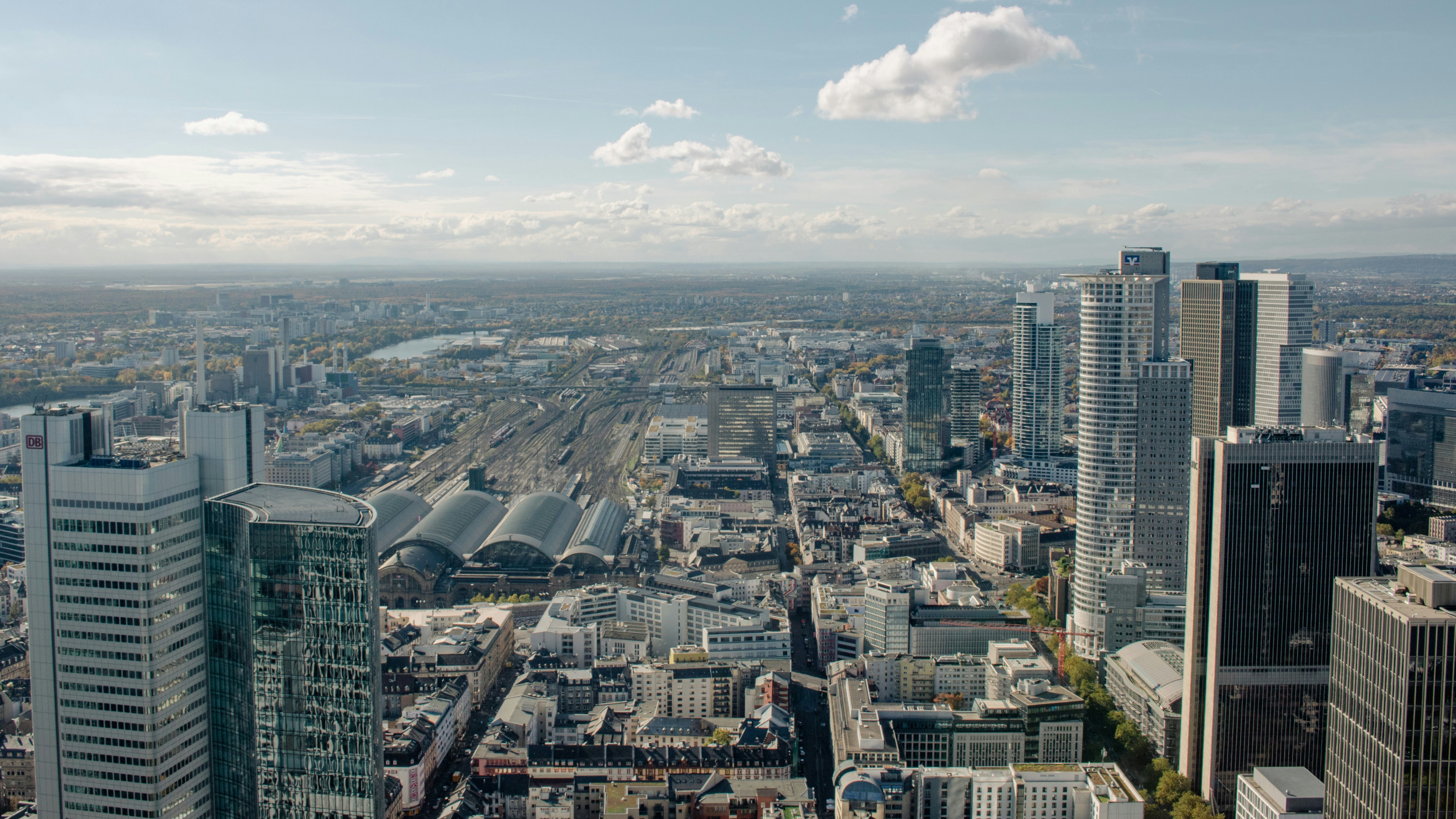 Vast cityscape showcasing a bustling urban environment with modern skyscrapers and railway lines. The scene captures the essence of metropolitan life.
