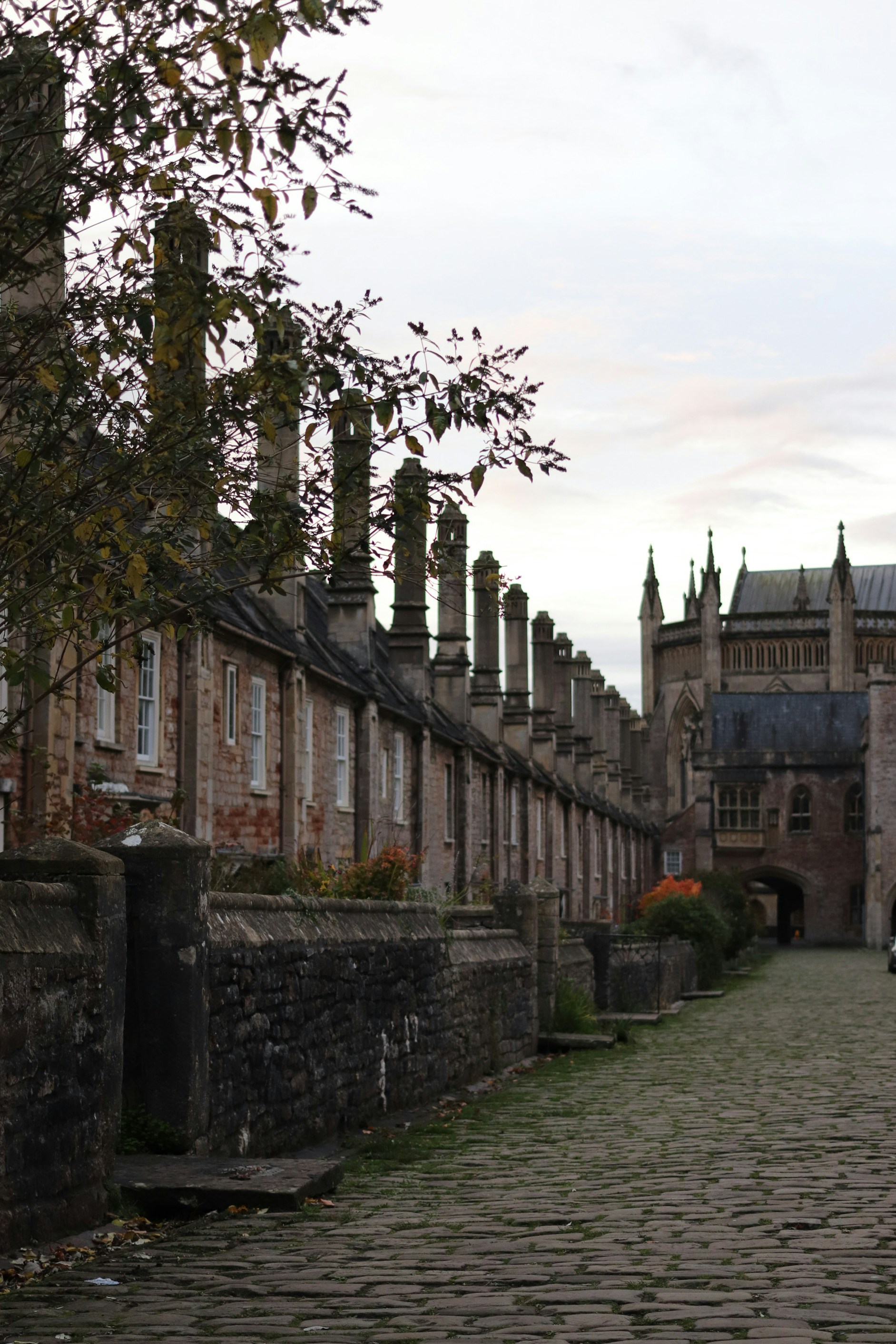 Cobblestone Corridor Toward a Gothic Arch