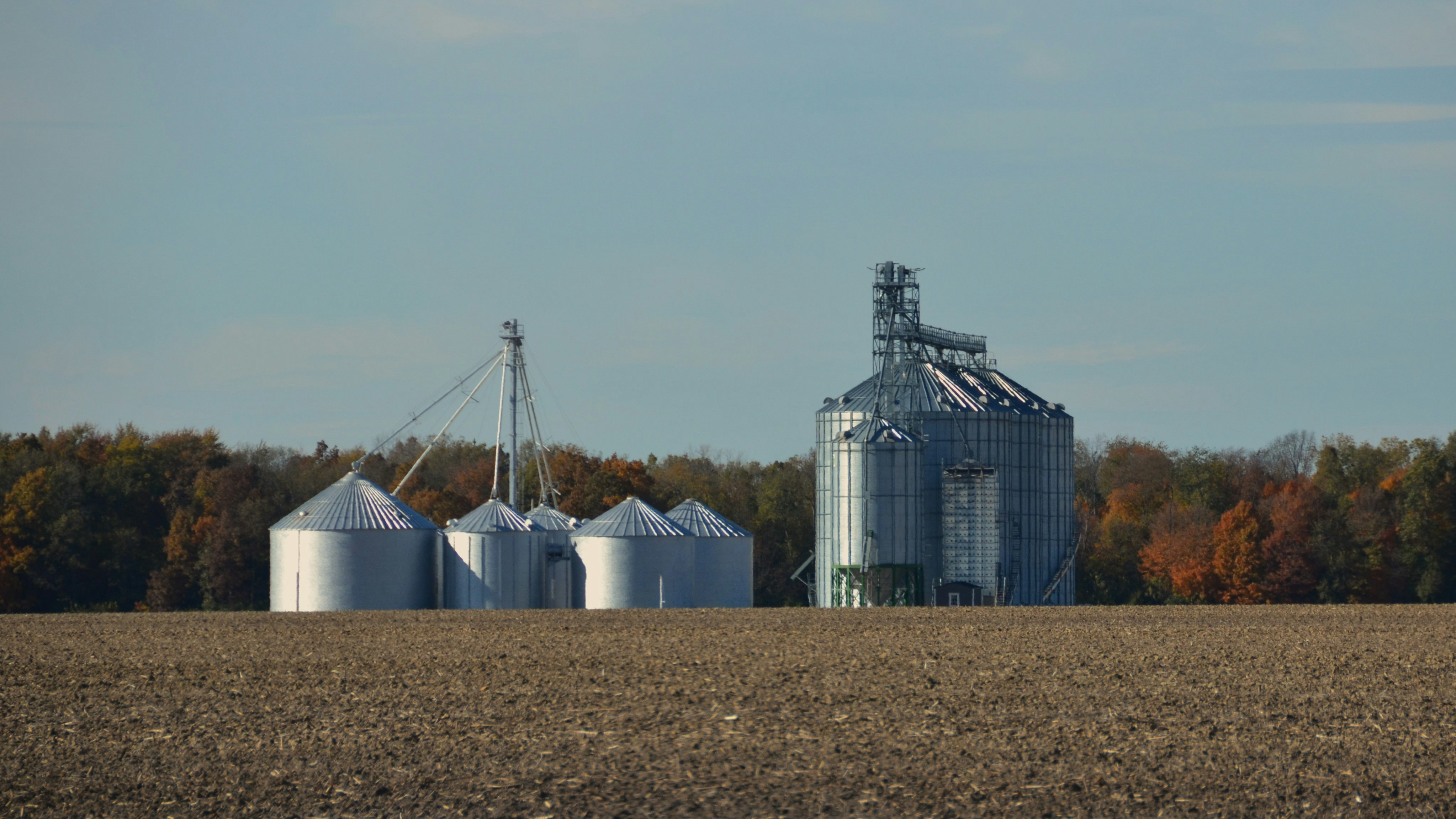 Farm silos stand against a clear autumn sky. photo – Free Farm Image on ...