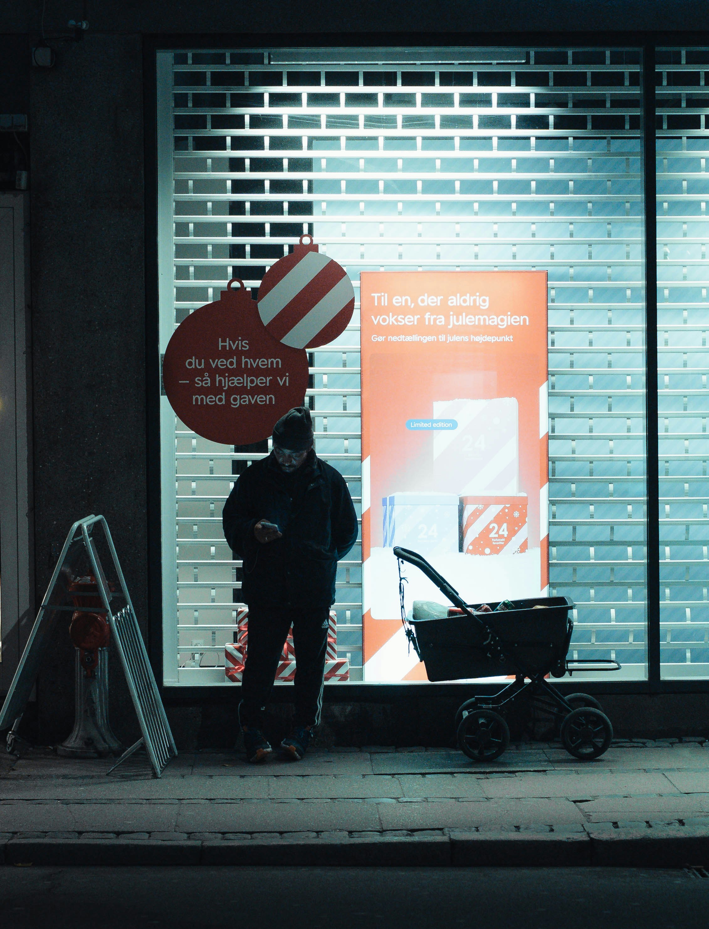 Night Watcher by the Shuttered Shopfront