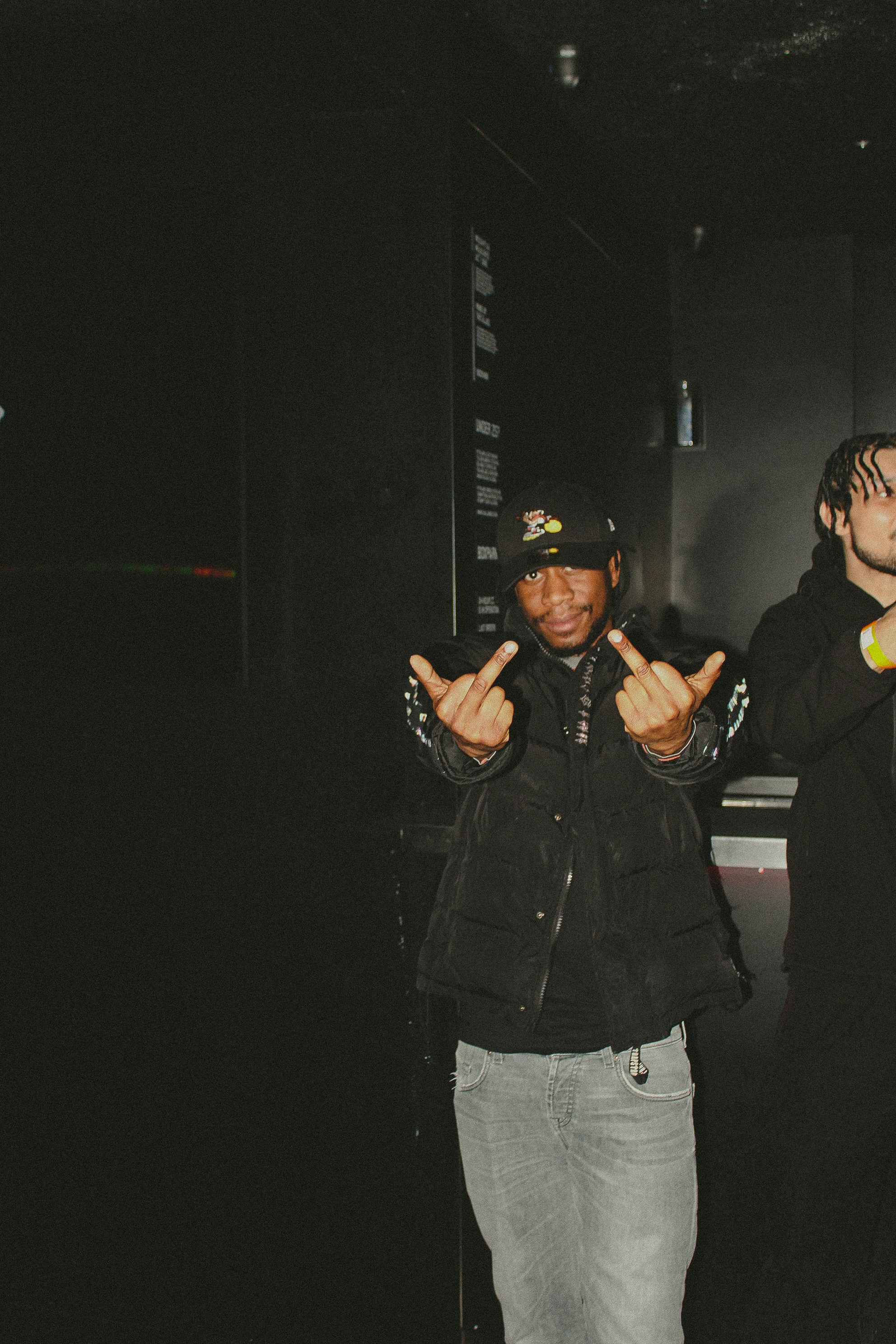 Backstage Defiance: Duo Under Shadowed Club Lights