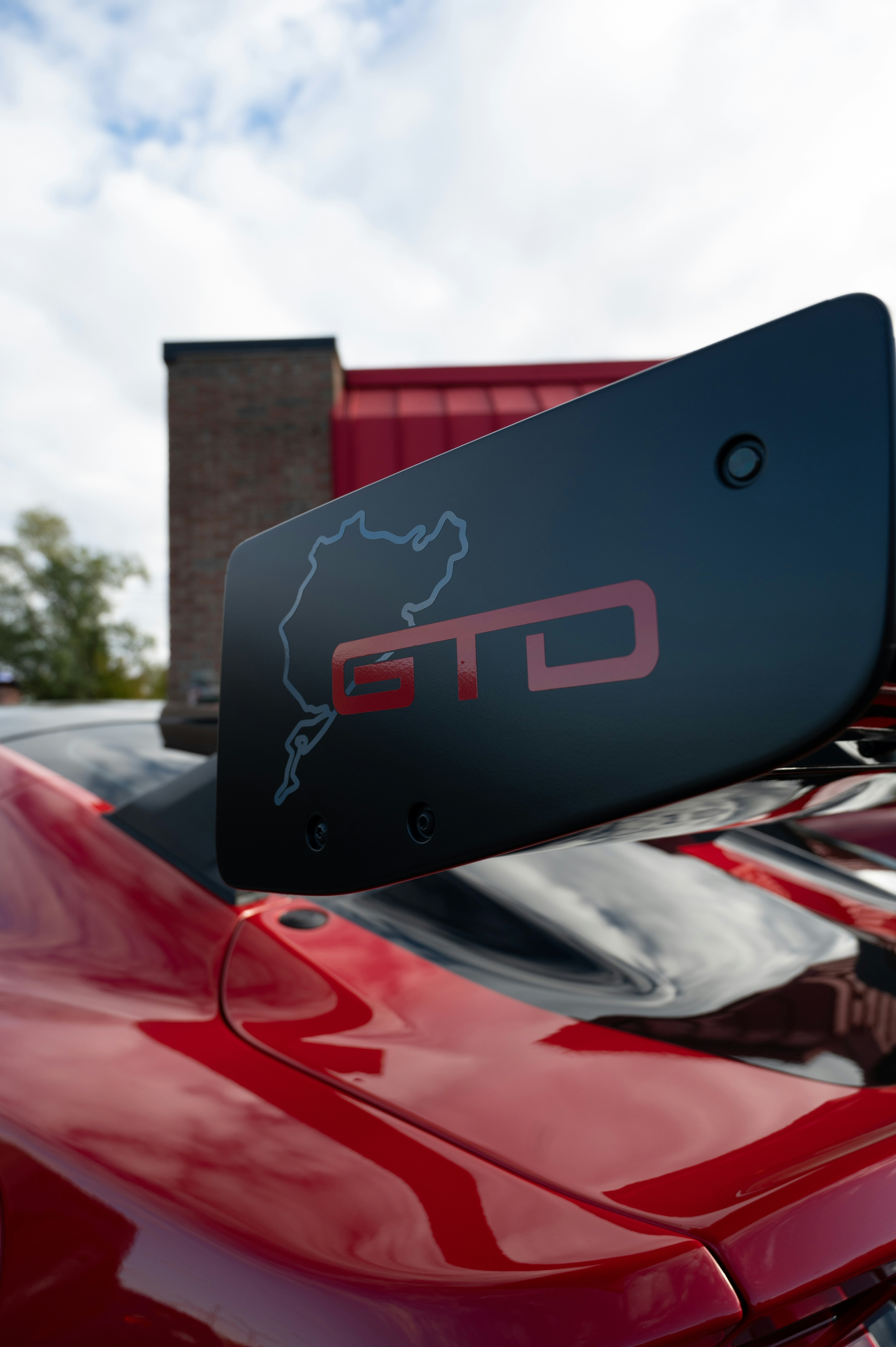 GTD Wing in Focus: A Red Sports Car's Aerodynamic Accent