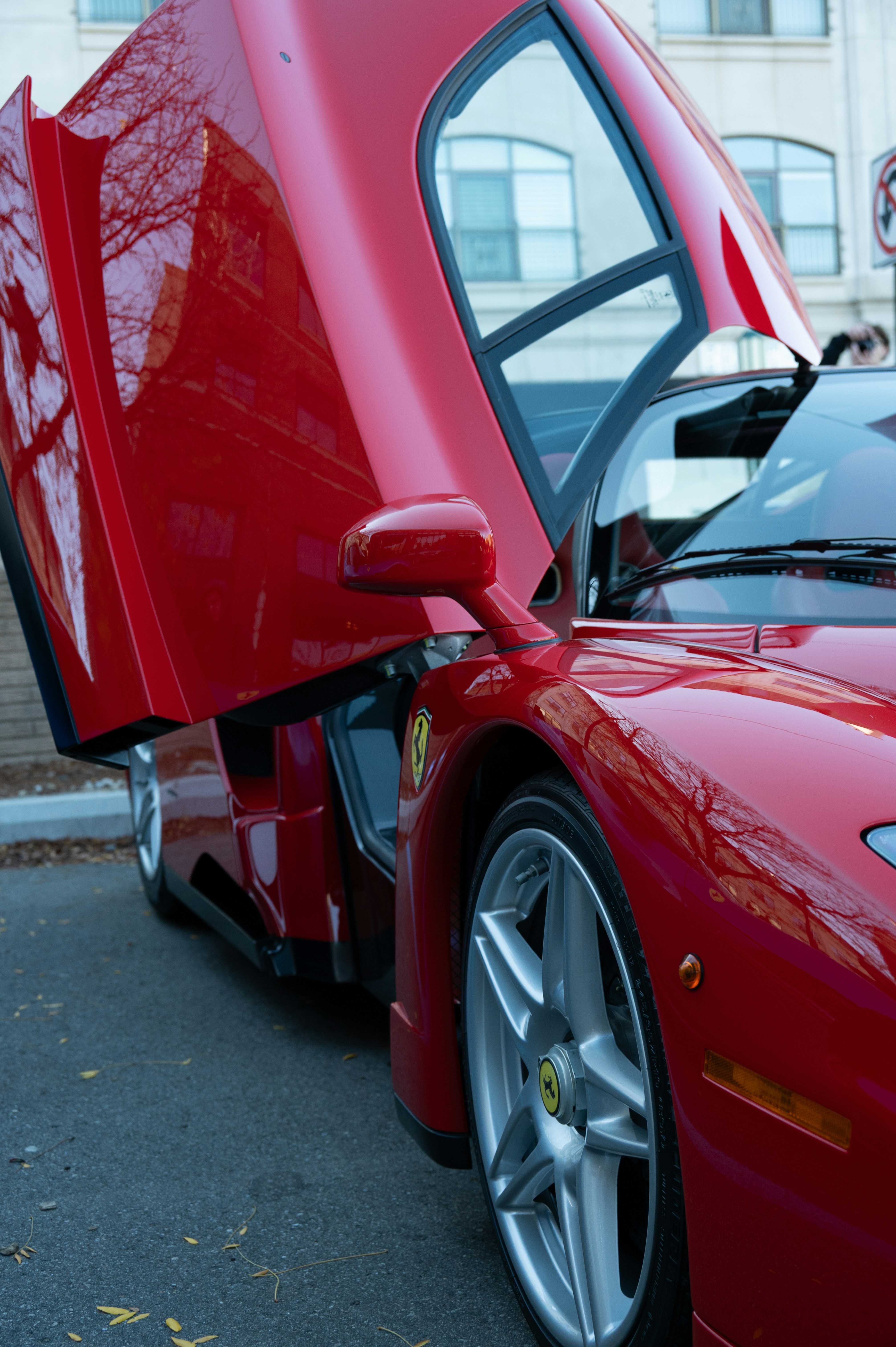 Crimson Stallion with Raised Doors: City-Street Spotlight on a Ferrari