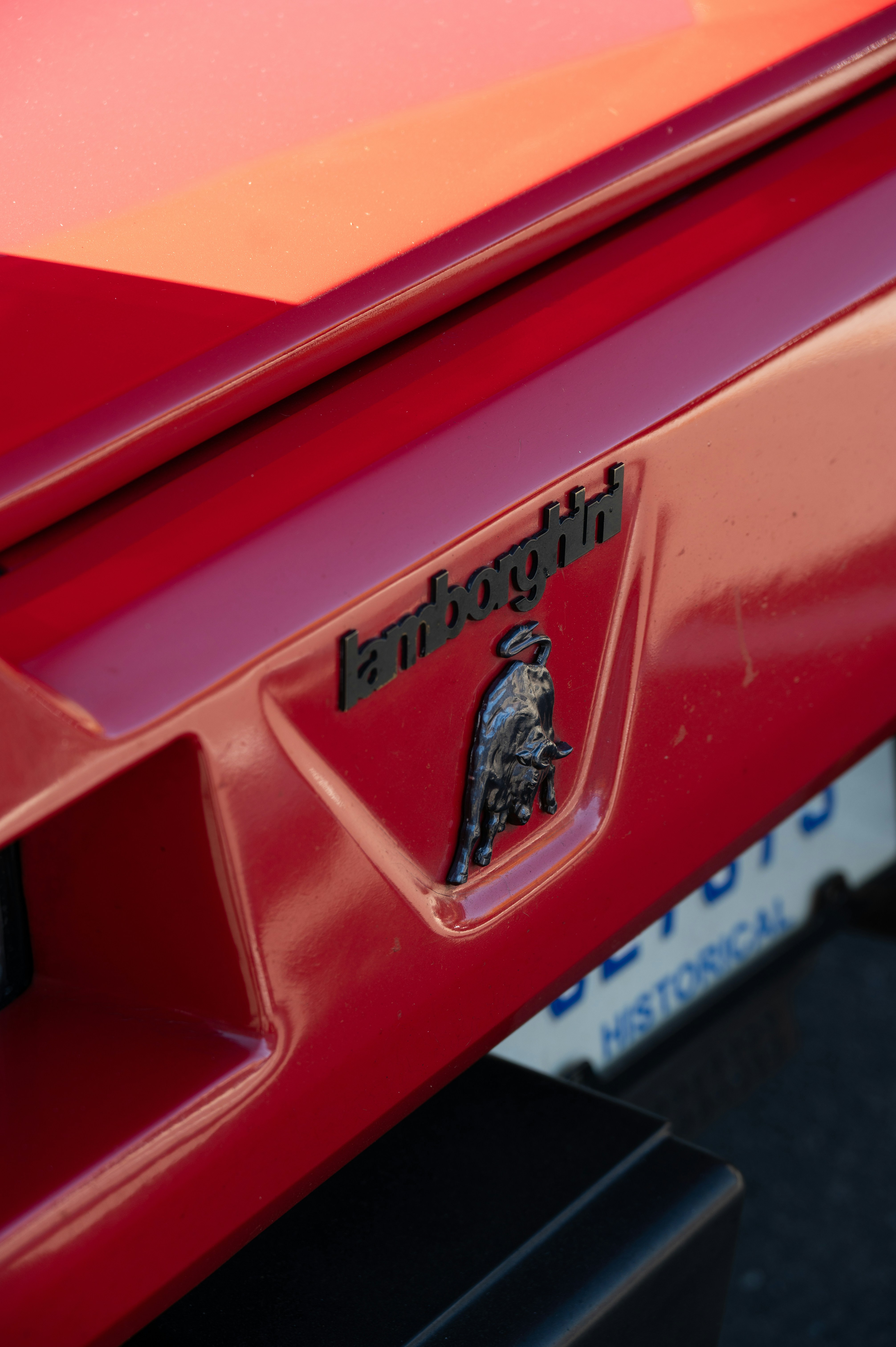 Lamborghini Emblem Nestled in a Glossy Red Rear Panel