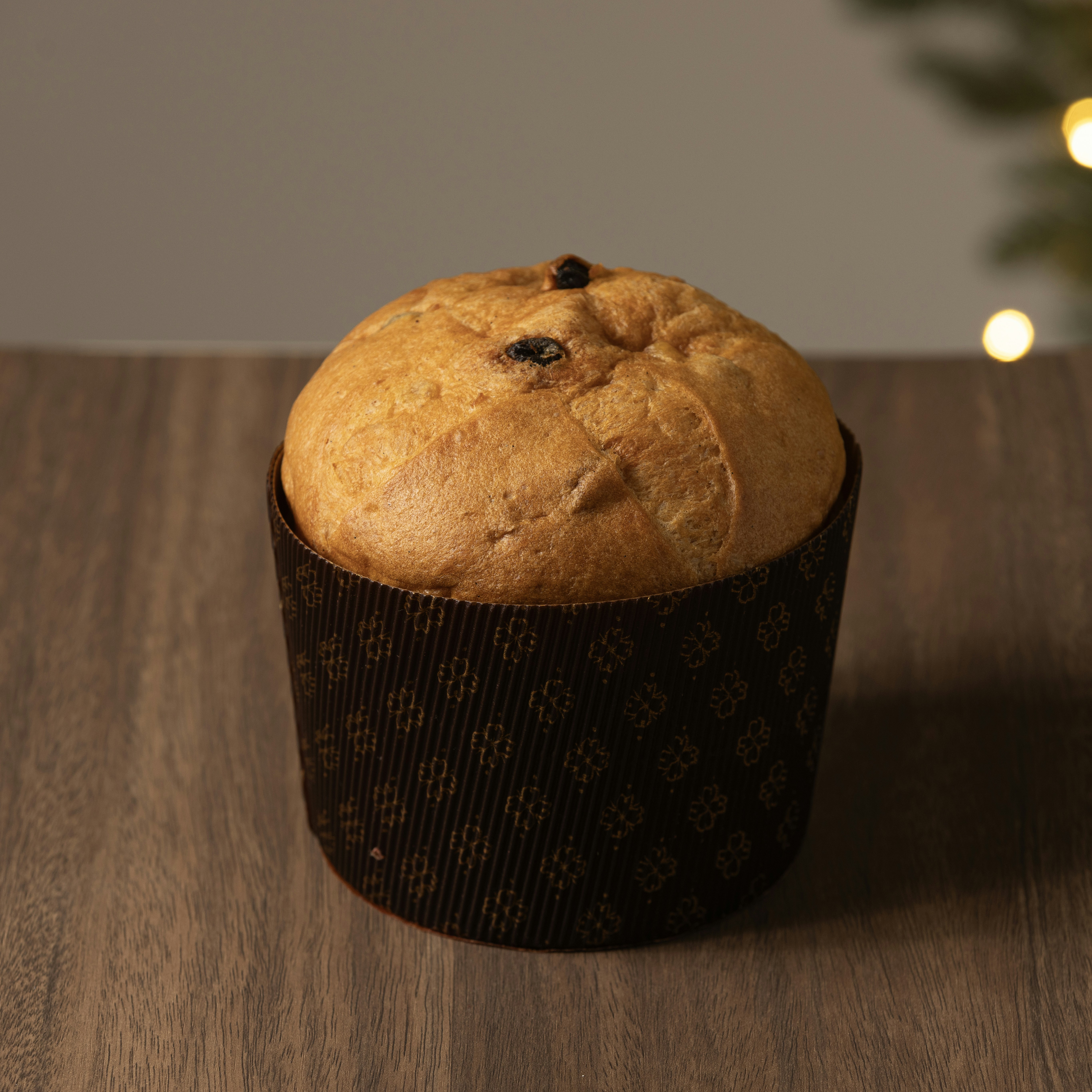 Golden Muffin Crowned by Warm Bokeh on a Wooden Stage