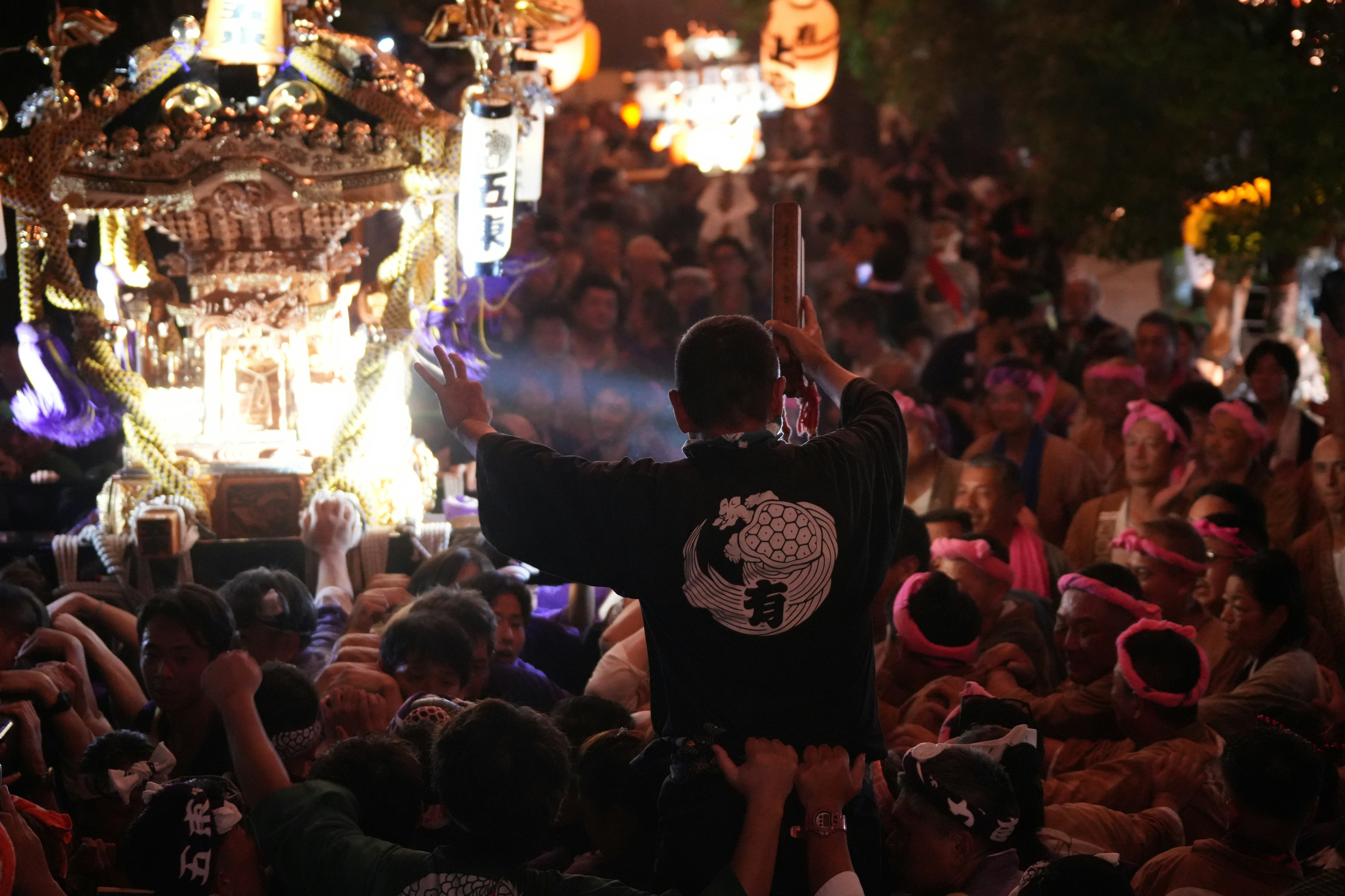Midnight Mikoshi Moment: A Festival Figure Lifted Above a Sea of Lanterns