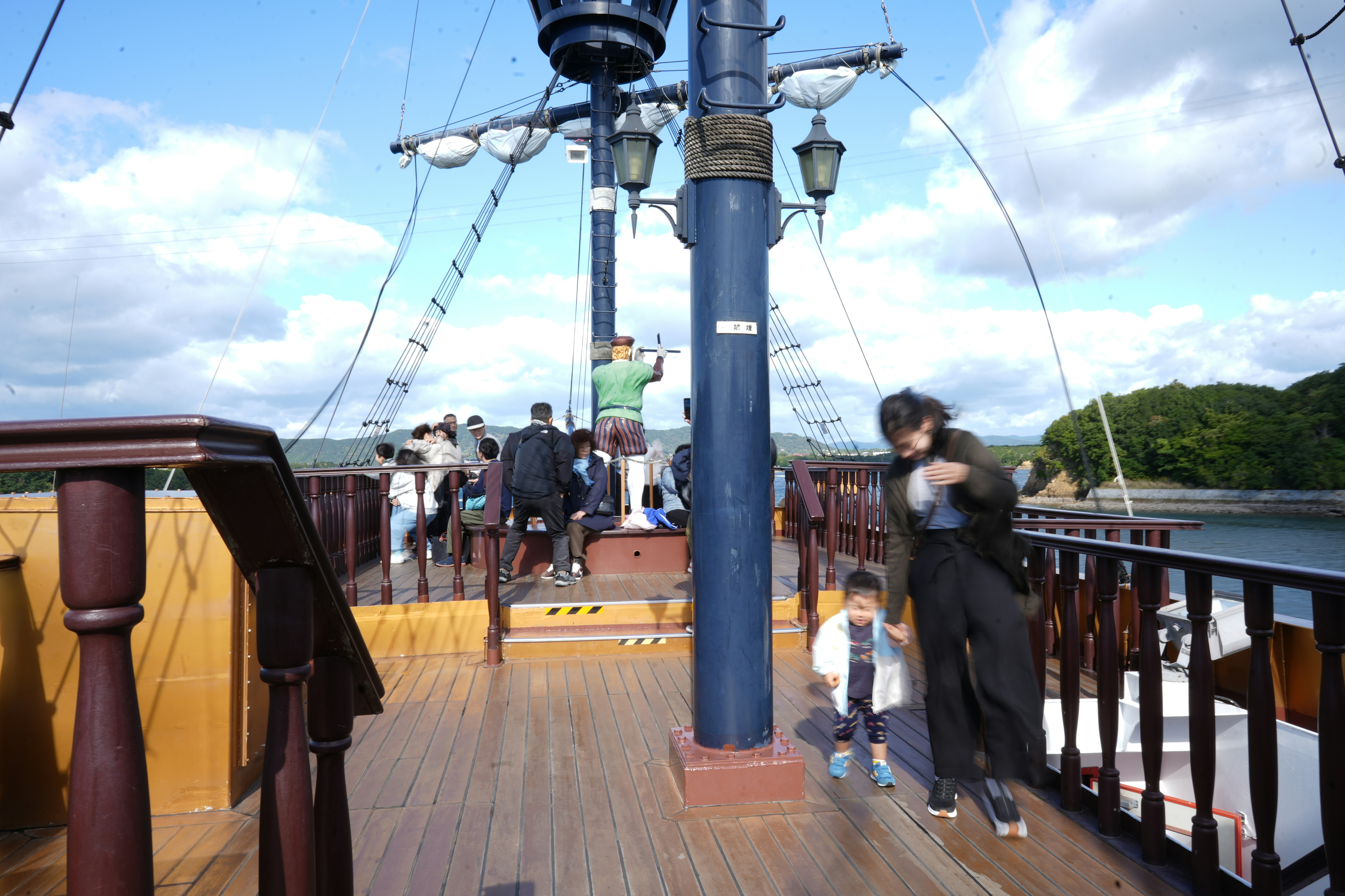 Timberdeck Moment: A Sunlit Sail with Moving Figures