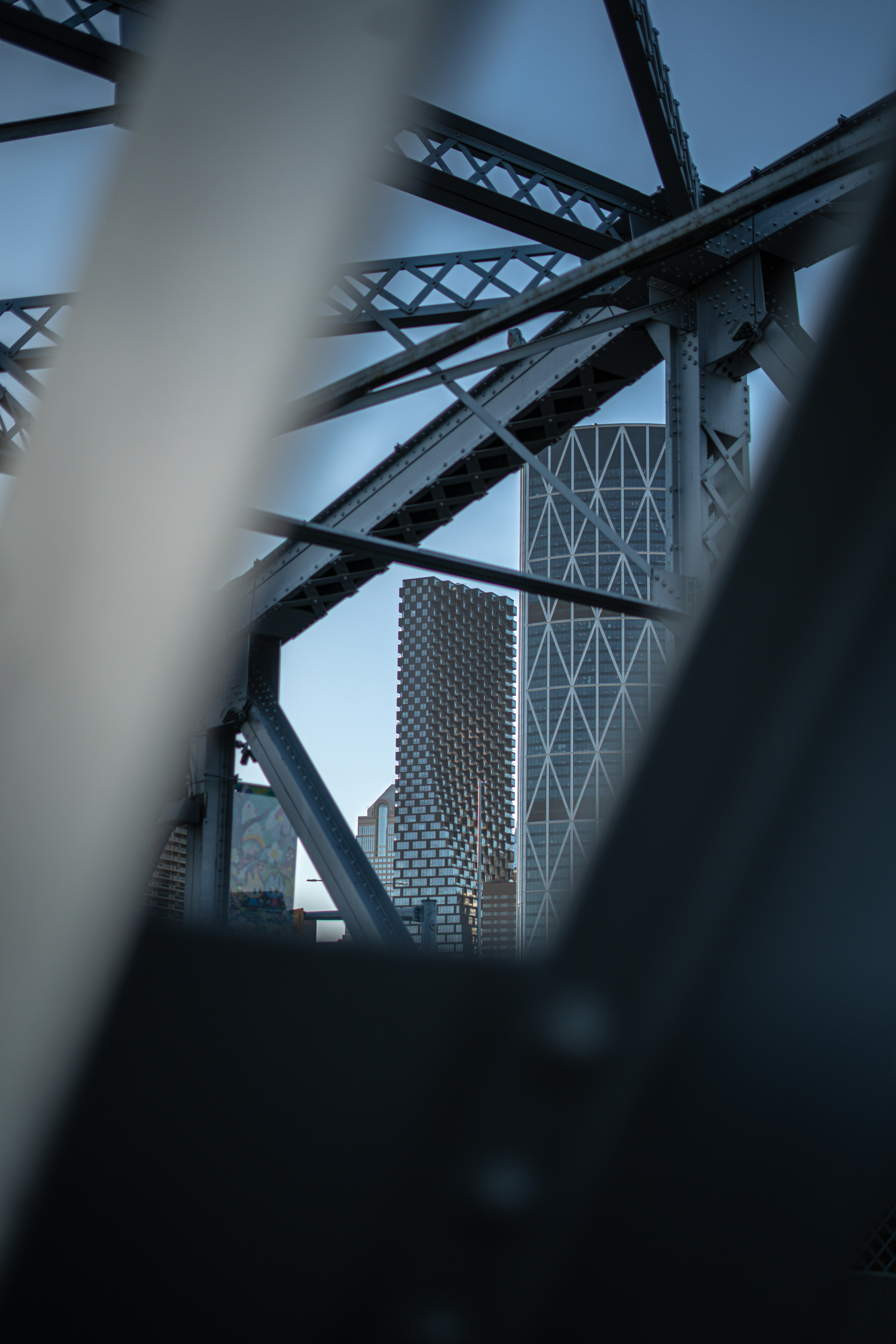 Crisscross of Steel: A City skyline framed through a Bridge