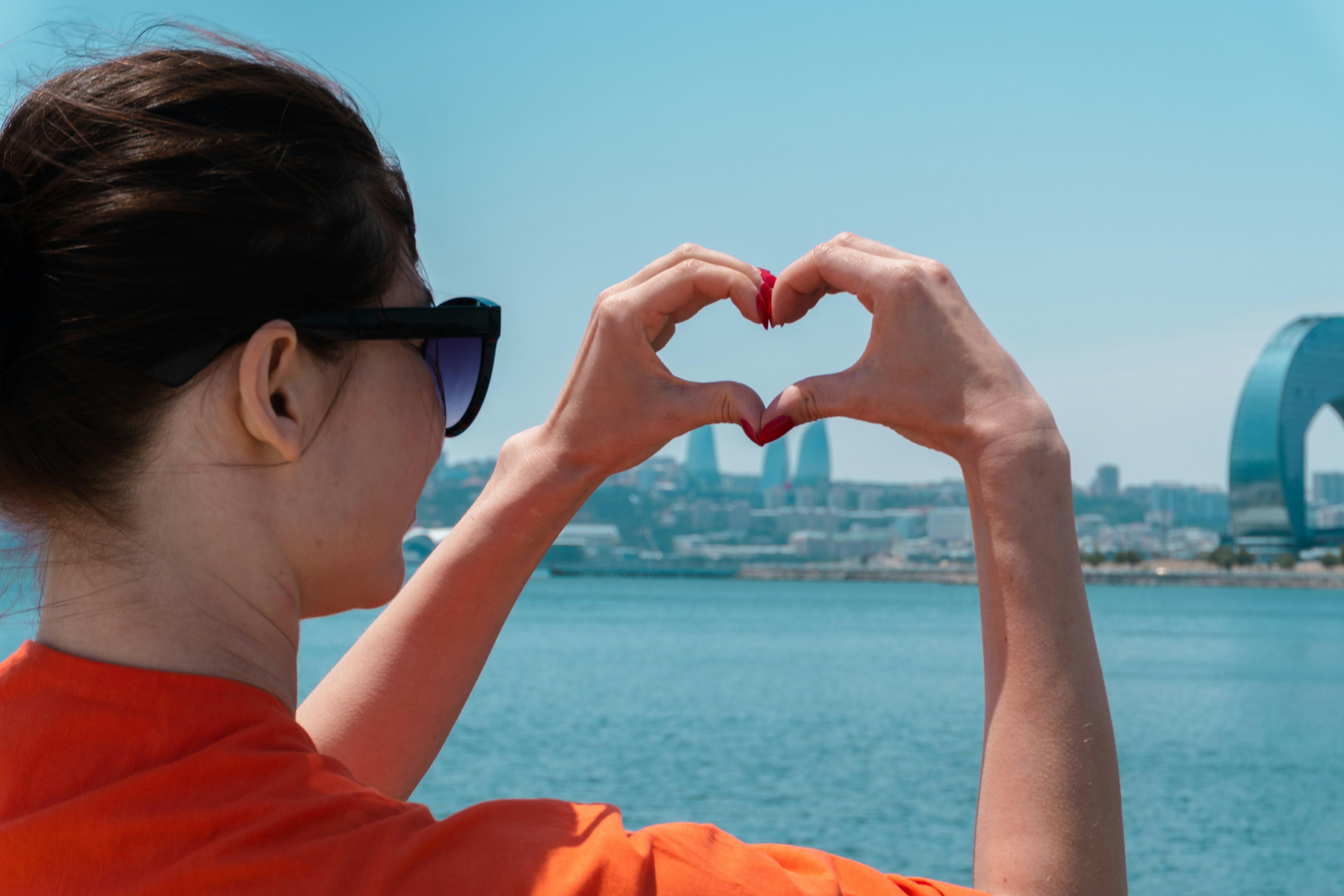 Blue Harbor Heart: Framing a City with a Hand-Heart Gesture
