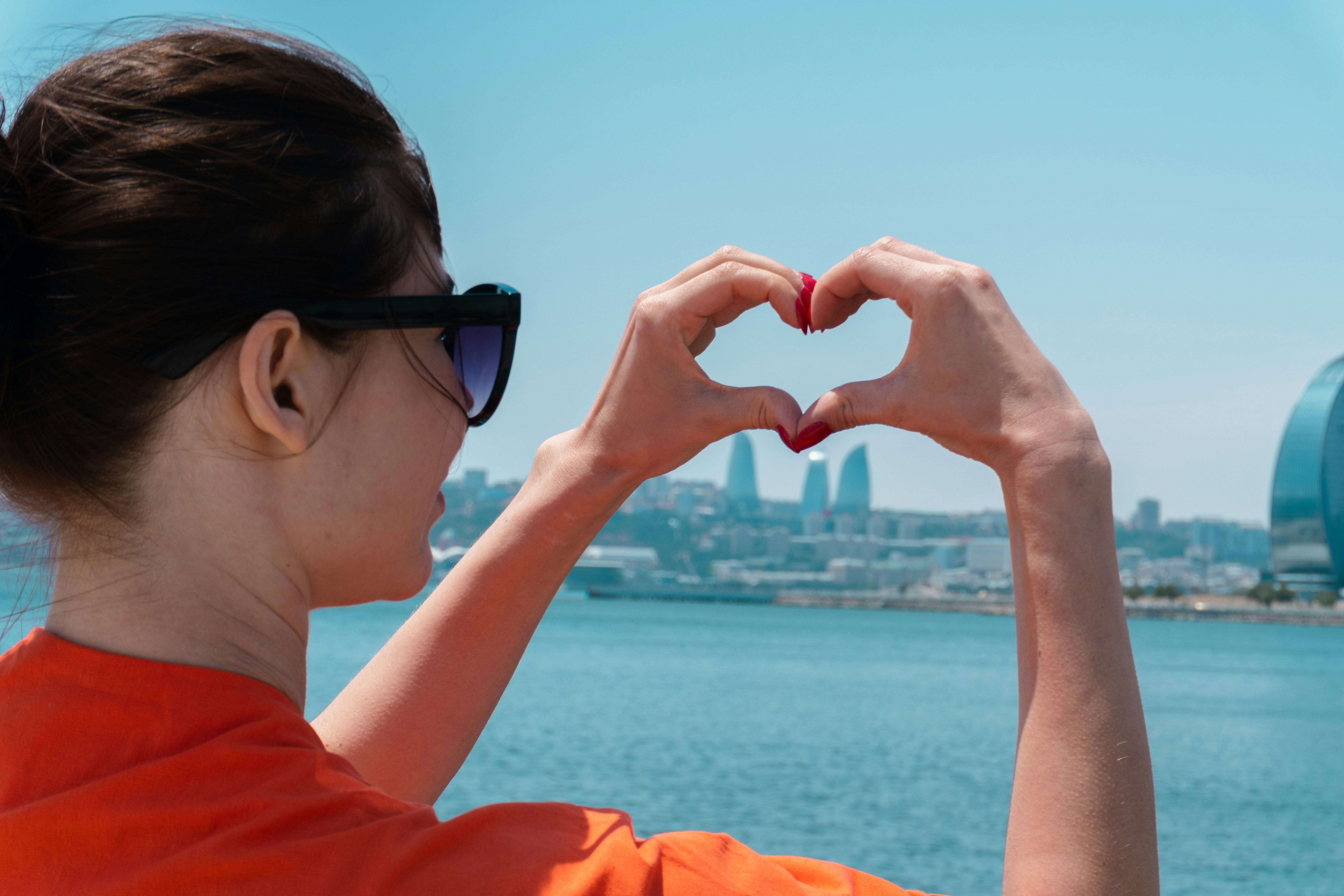 Heart Hands Over an Azure Waterfront Skyline