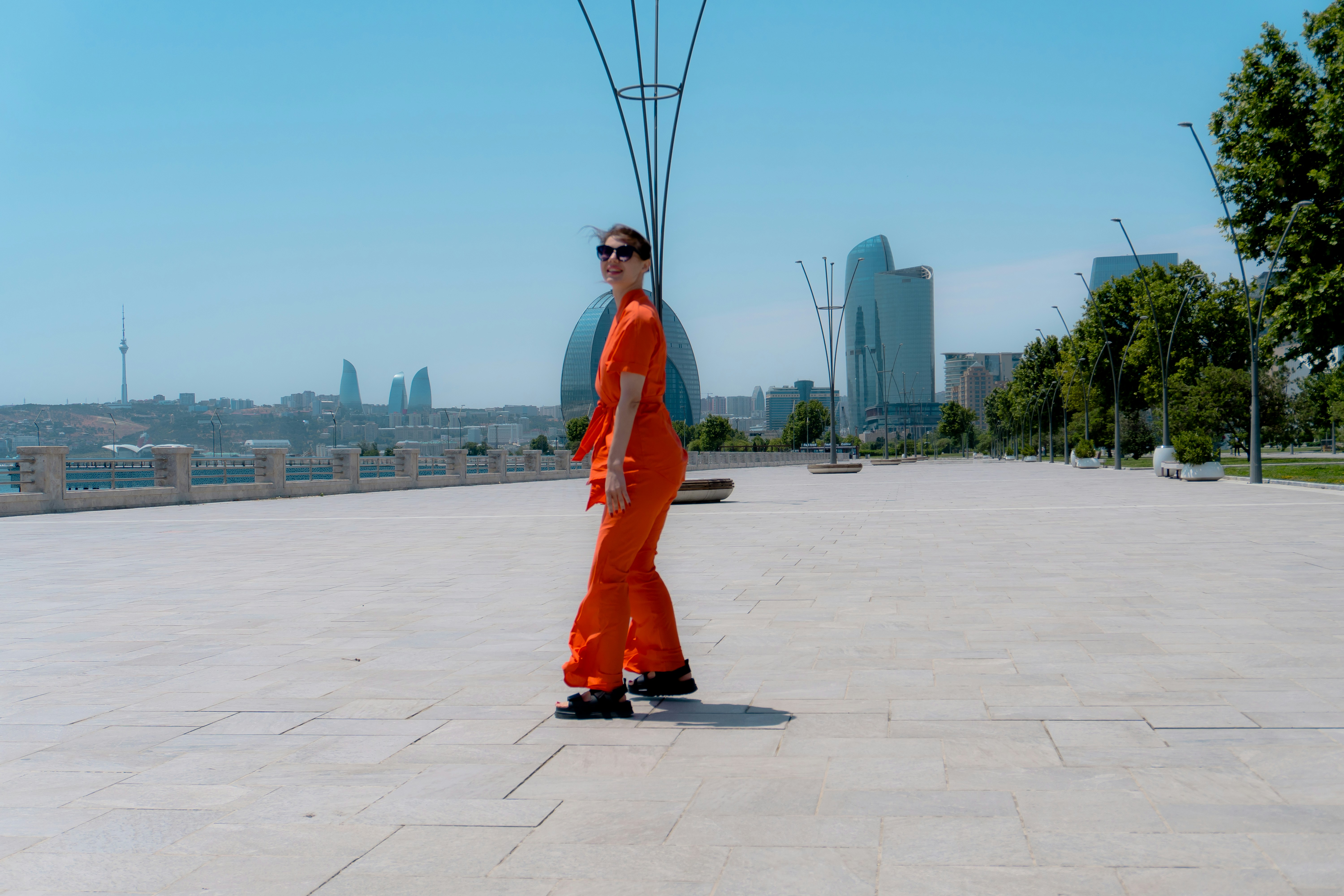 Orange Overlook: A Solo Runner in a Modern Waterfront Promenade