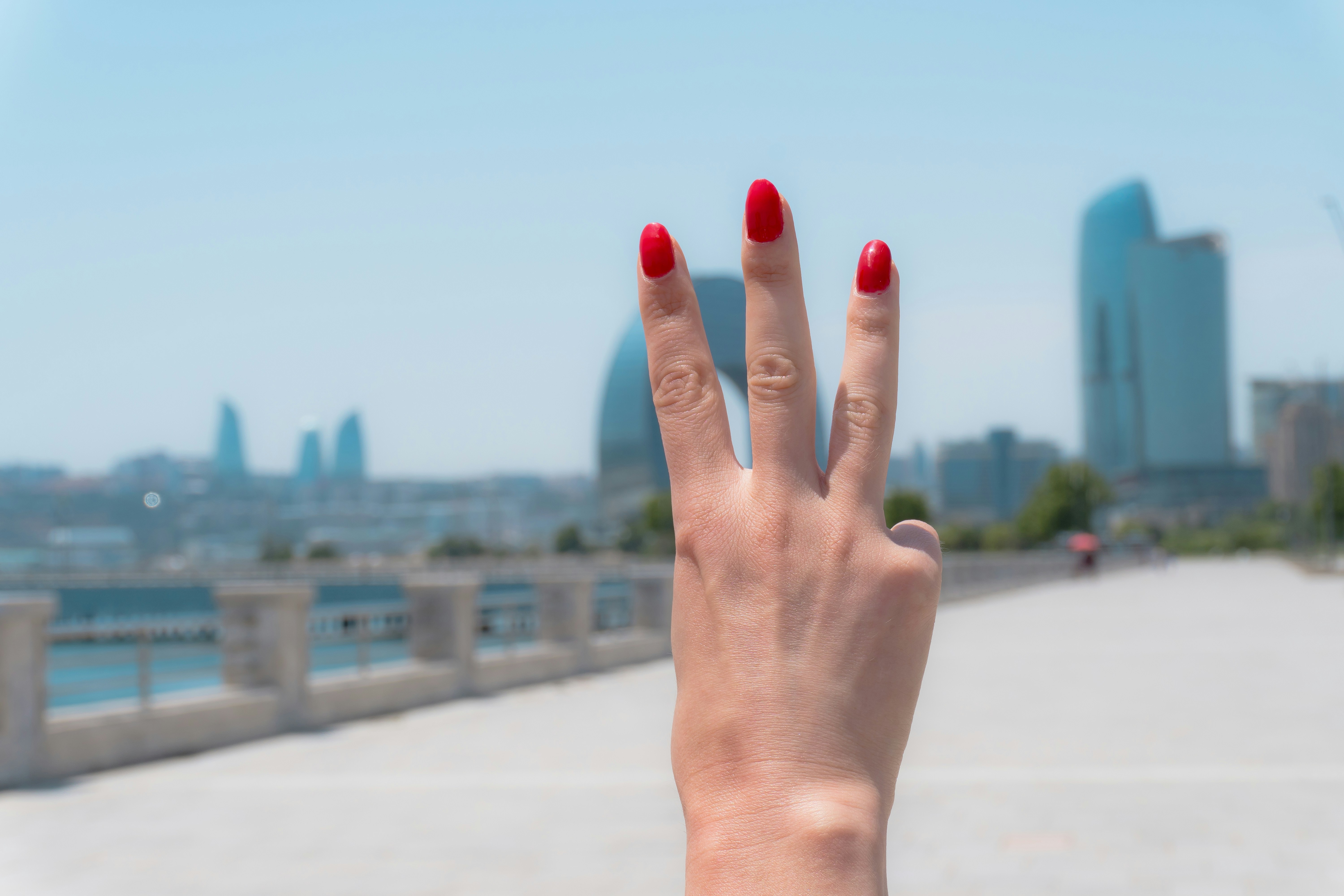 Three-Finger Gesture in Sharp Foreground, Skyline in Soft Focus