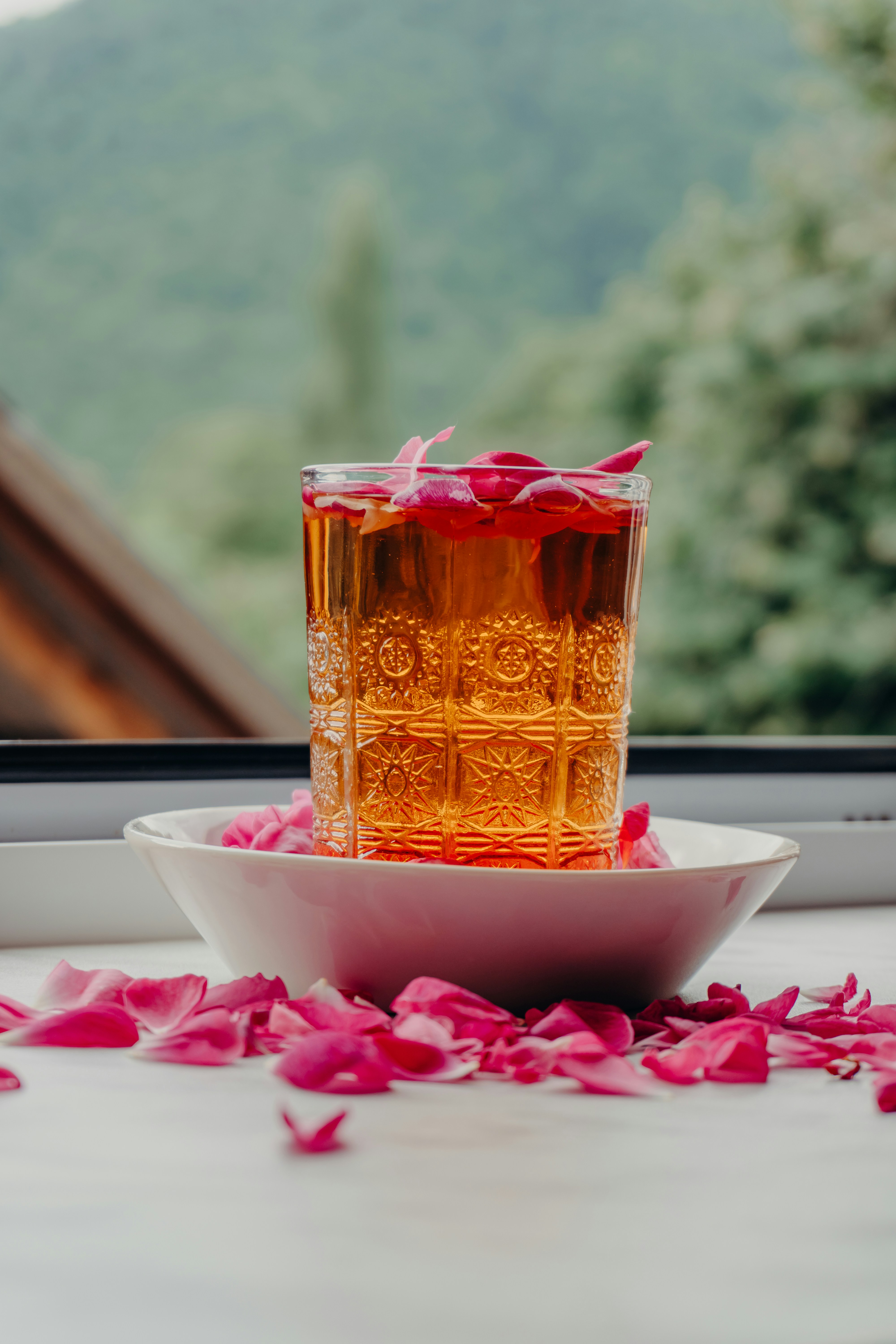 Amber Iced Tea on a Petal-Strewn Window Sill
