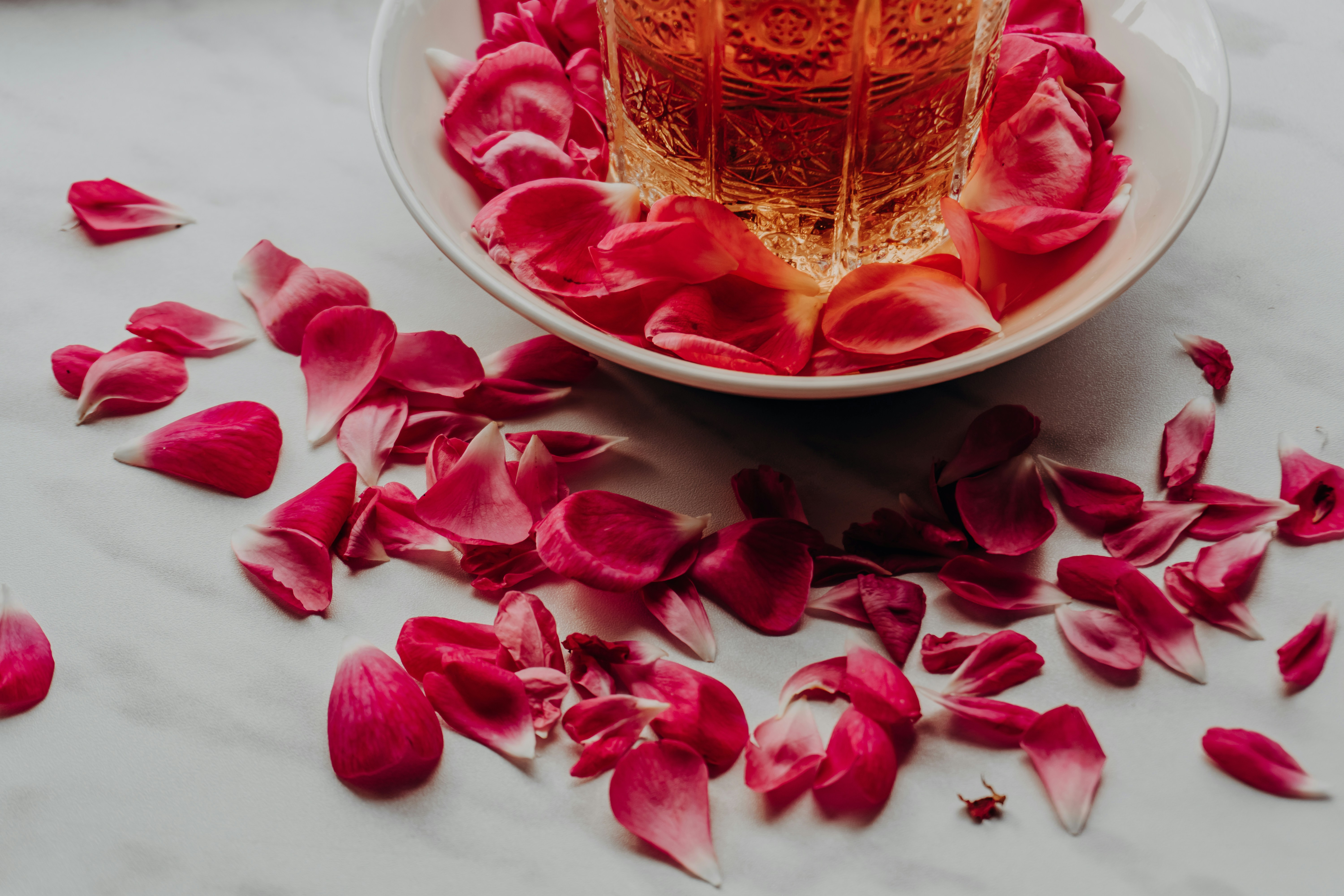 Amber Tea Amid Rose Petals on Marble Still-Life