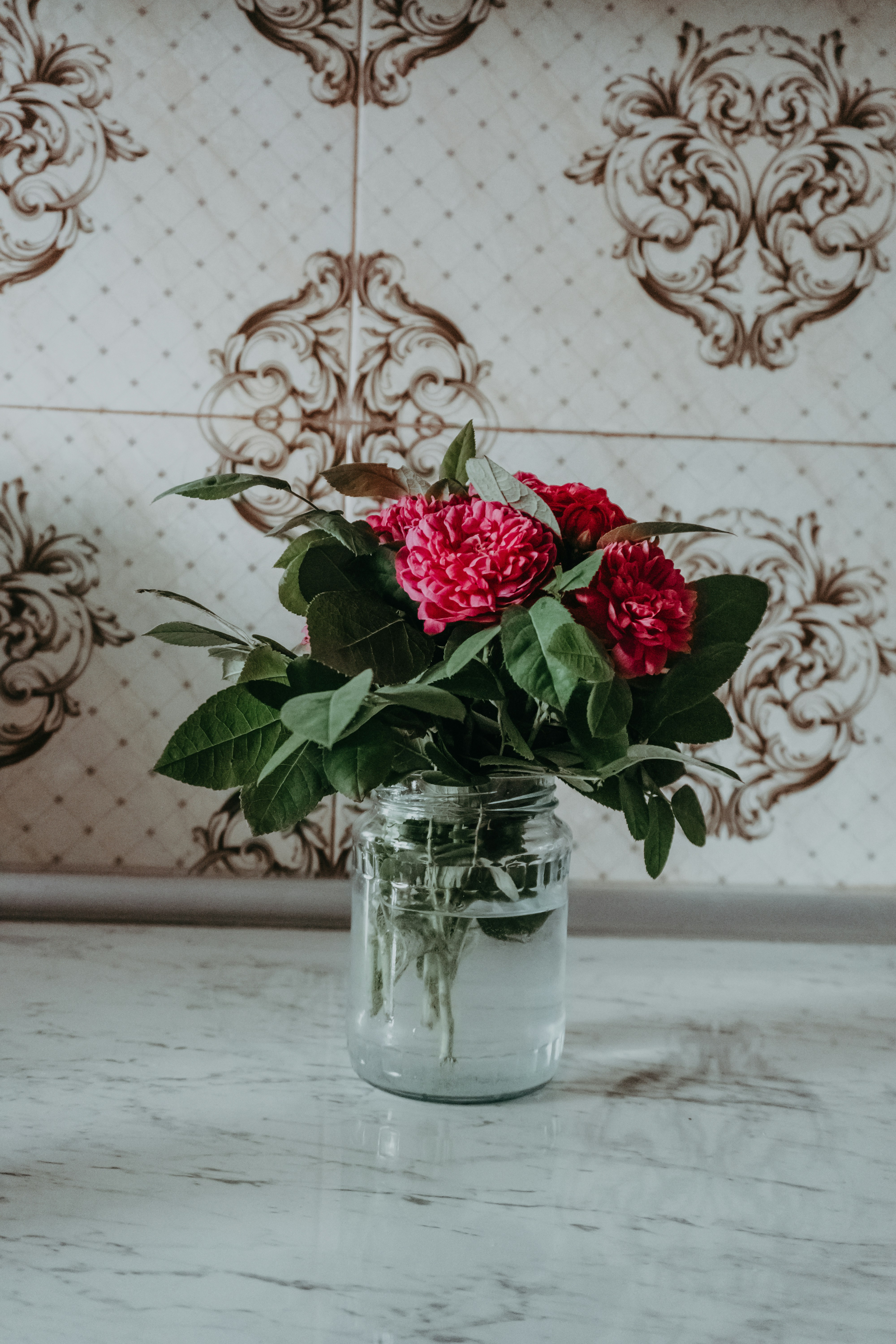 Crimson Peonies in a Glass Jar: Quiet Moment on Marble