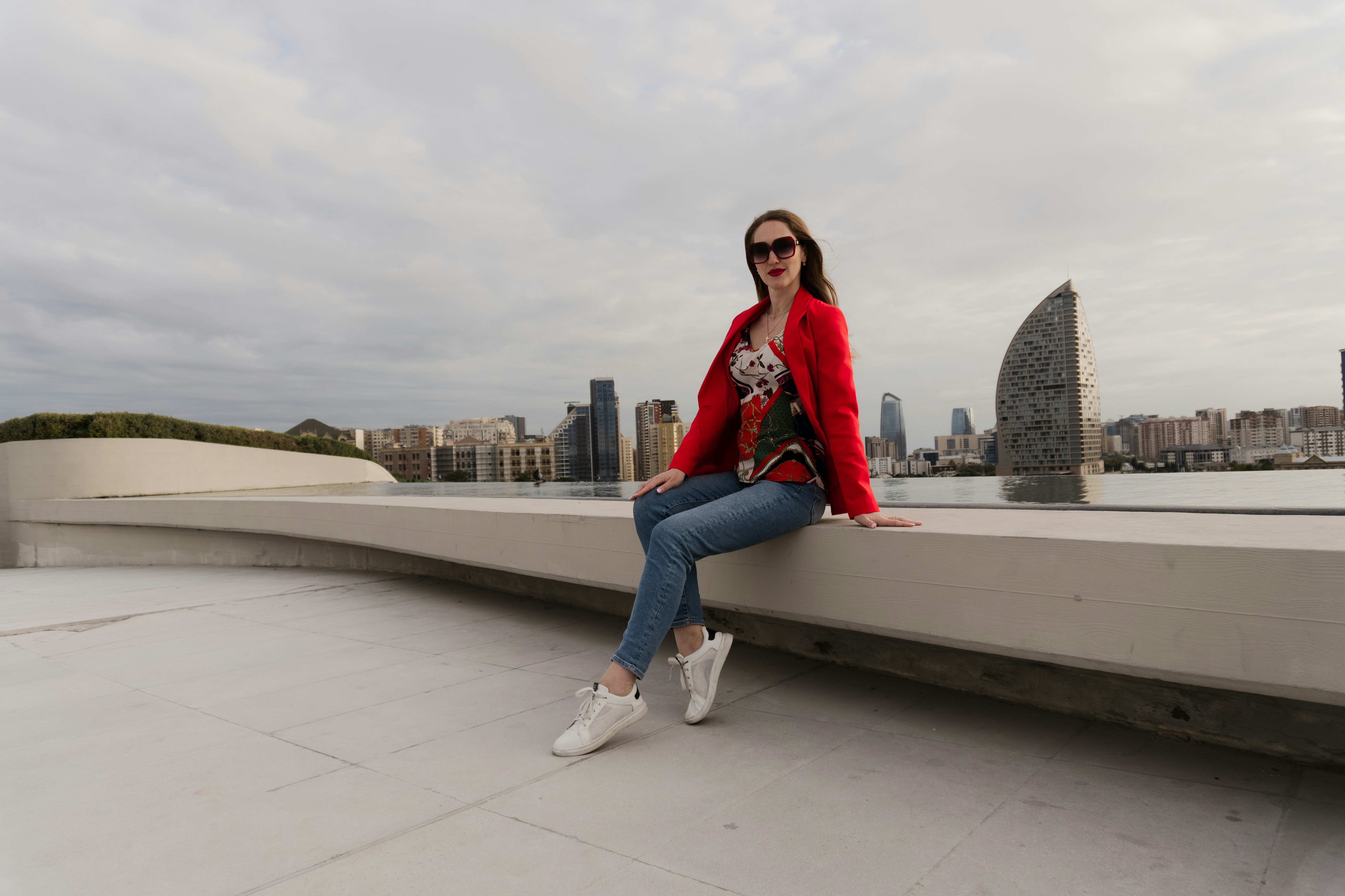 Cityscape Muse: Red Jacket on the Edge of the Pier