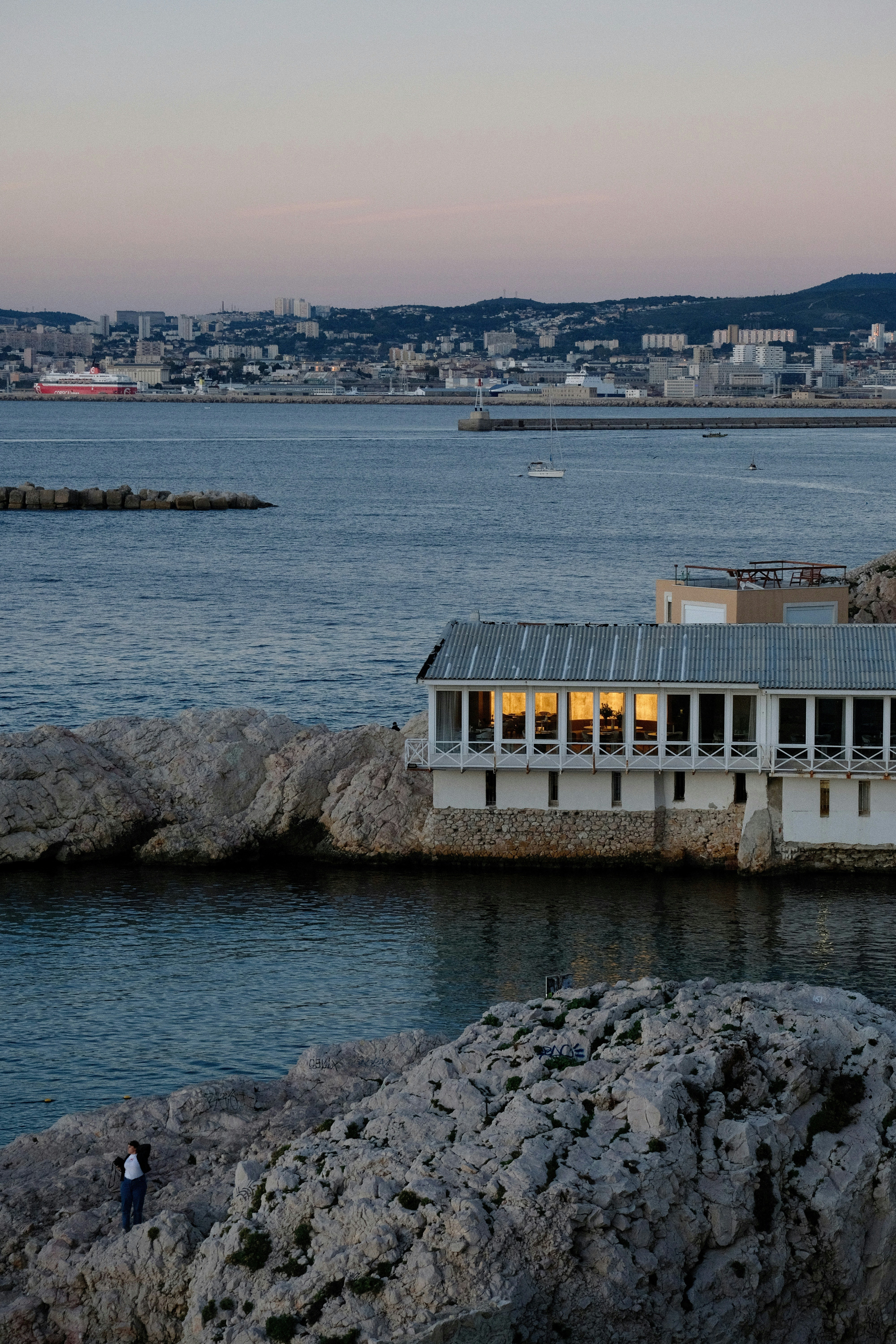 Sunlit Cliffside Café Overlooking a Quiet Harbor